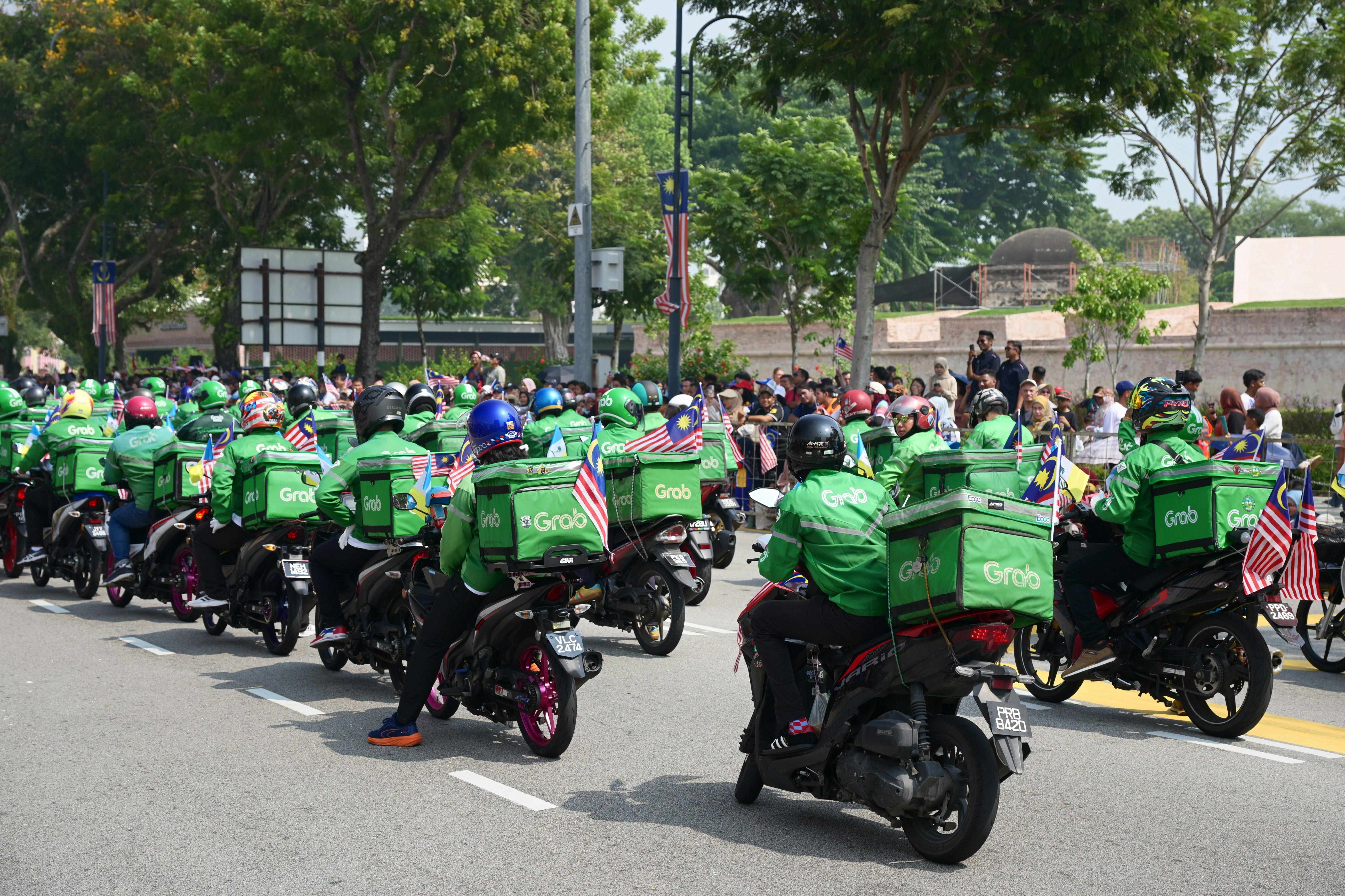 Green‑era Parade: A Line of Grabbing Green on Wheels