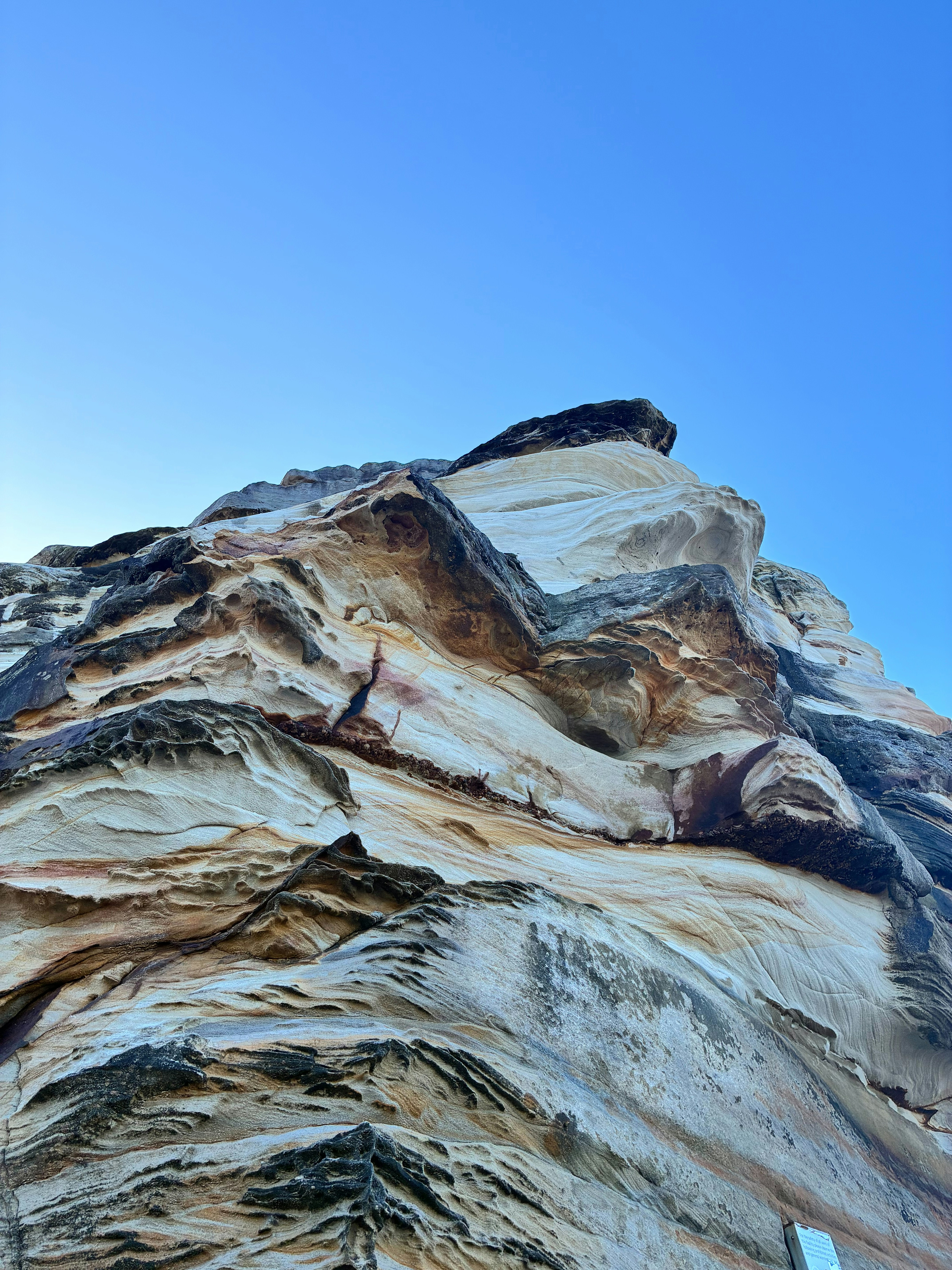 Weathered sandstone peaks under a cloudless blue sky