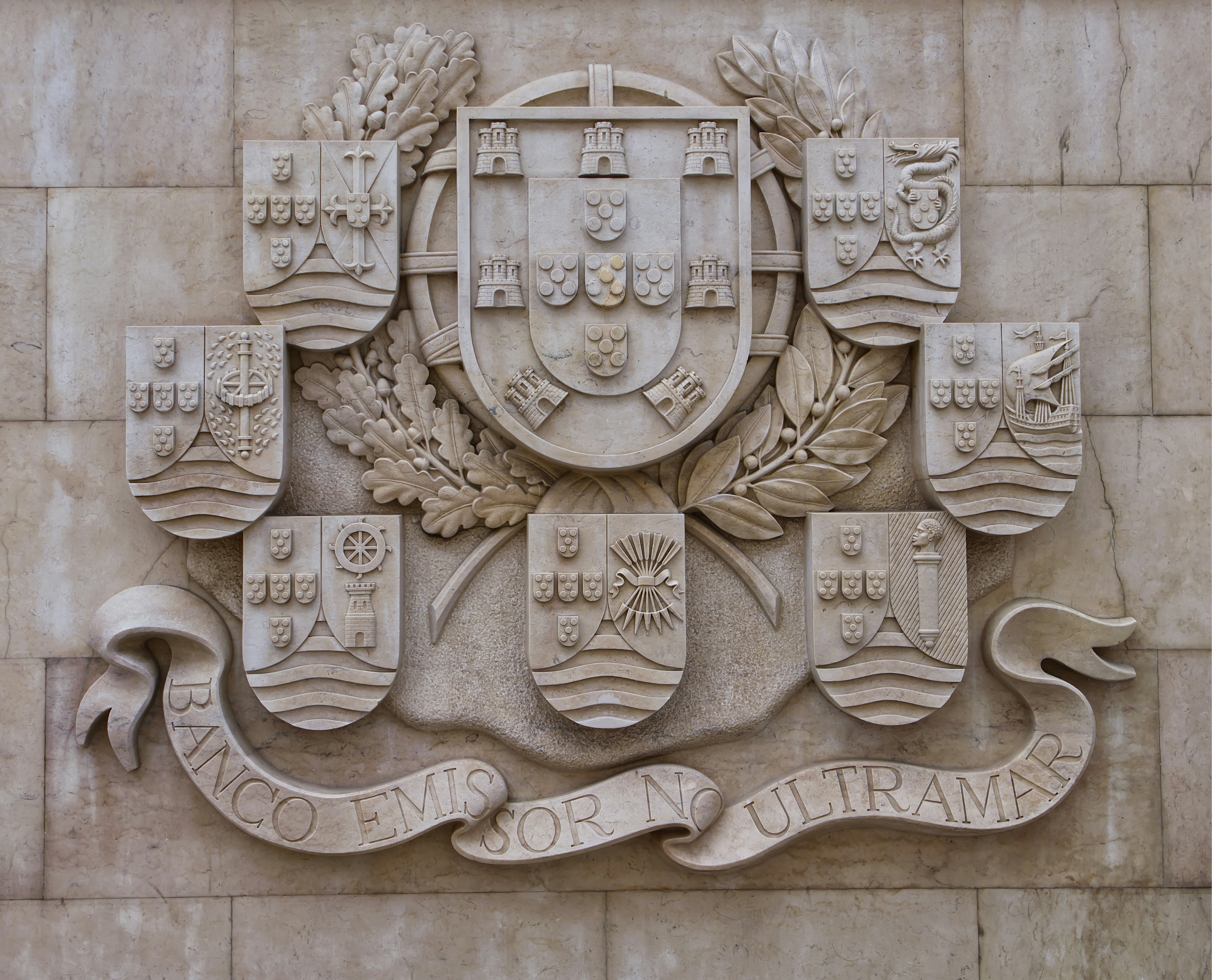 Emblem in Stone: Portuguese Coat of Arms Framed in Gilded Laurel Carving