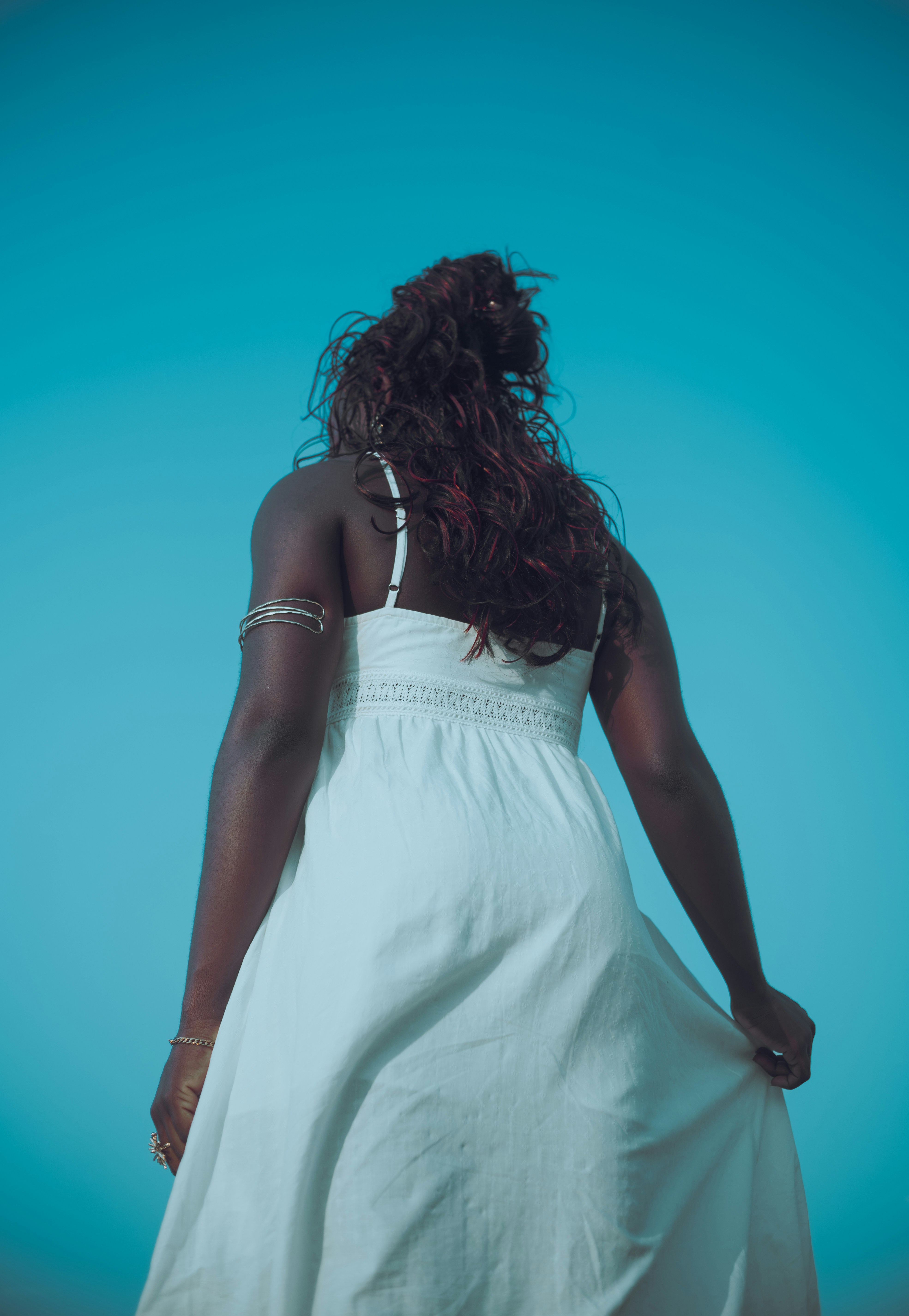 White dress, blue sky: a silhouetted backstory in sunlight