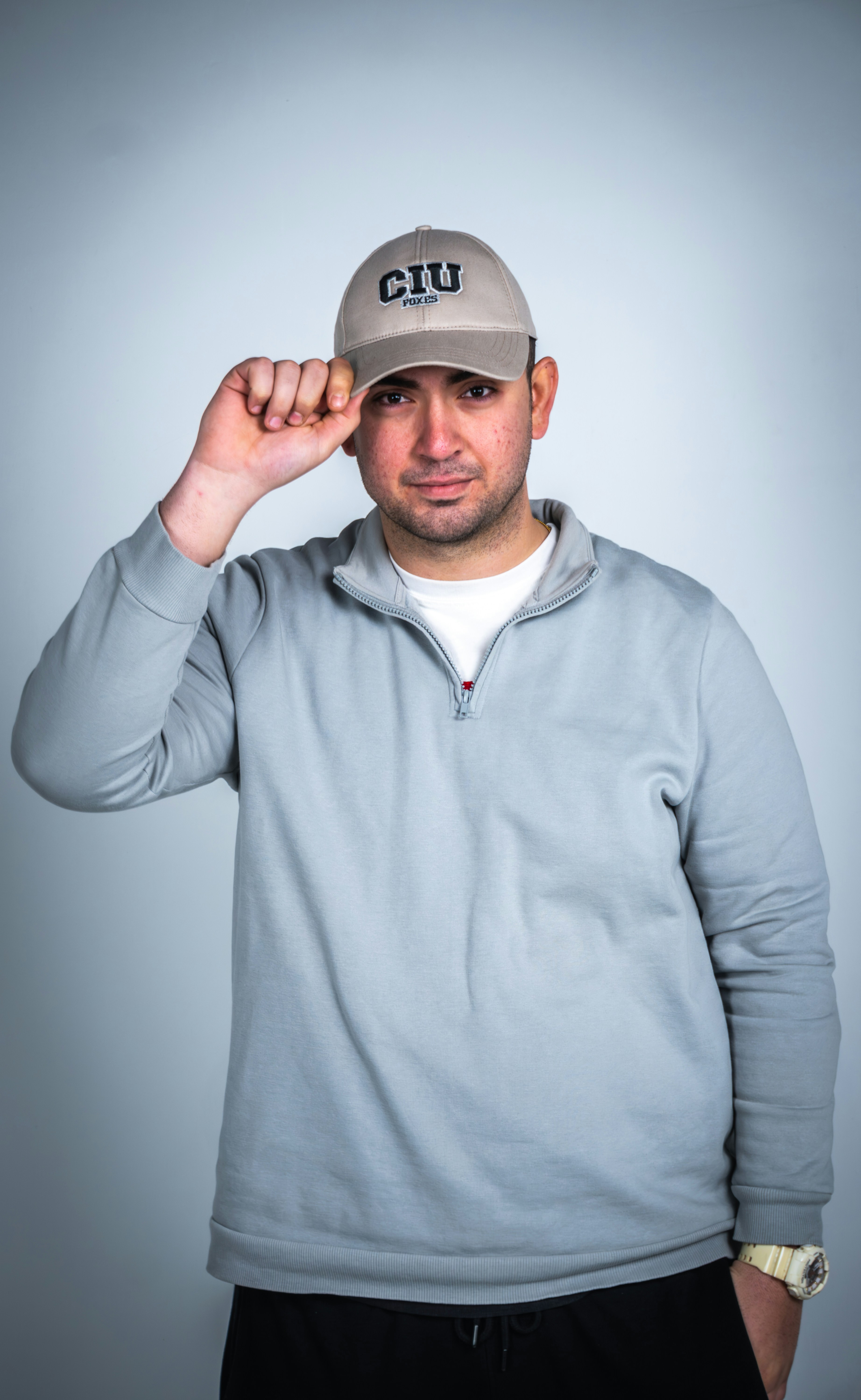 Cap and Confidence: A Casual Portrait in Soft Studio Light