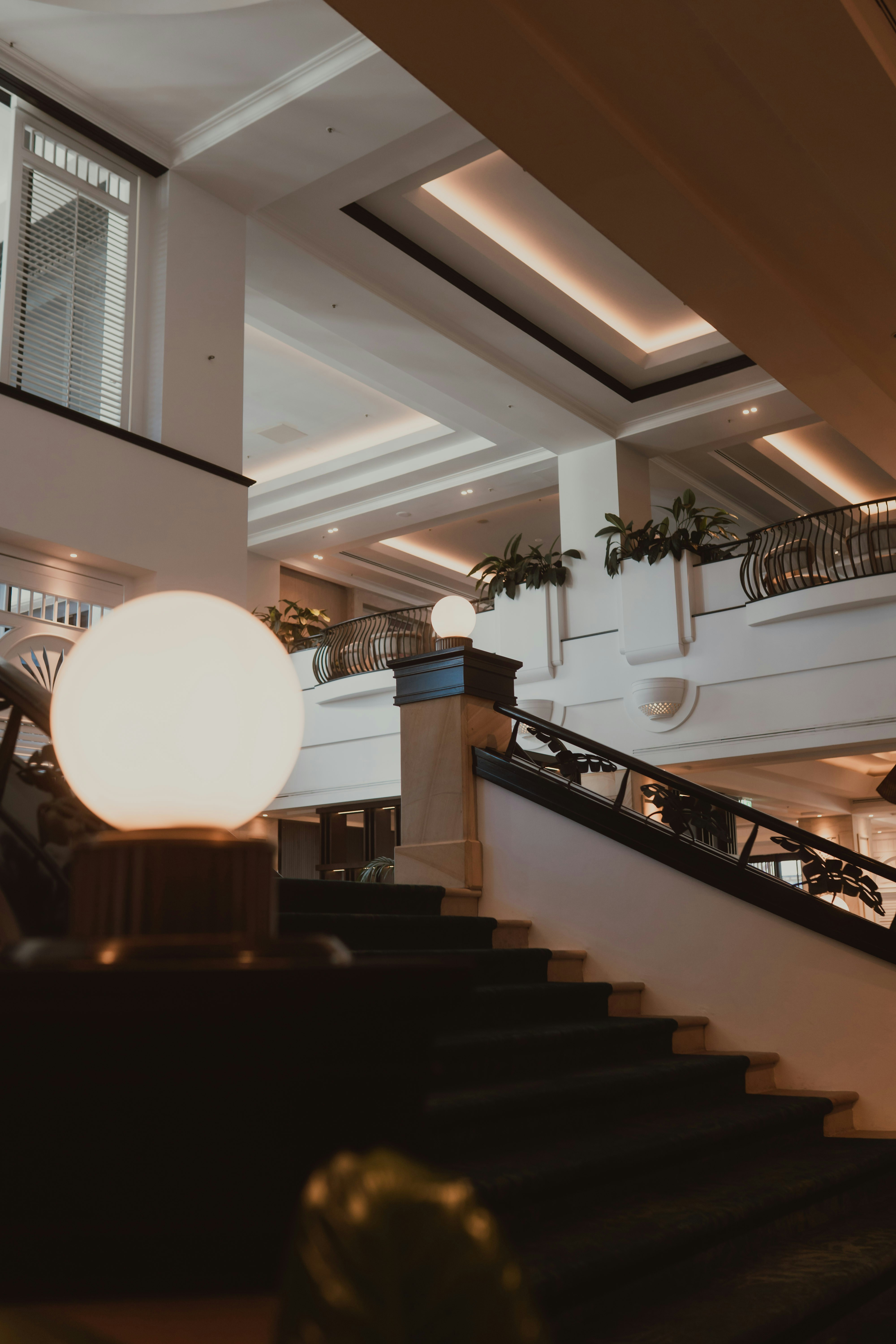 Grand Hotel Atrium Glow: Orbs, Stairs, and Soft Light