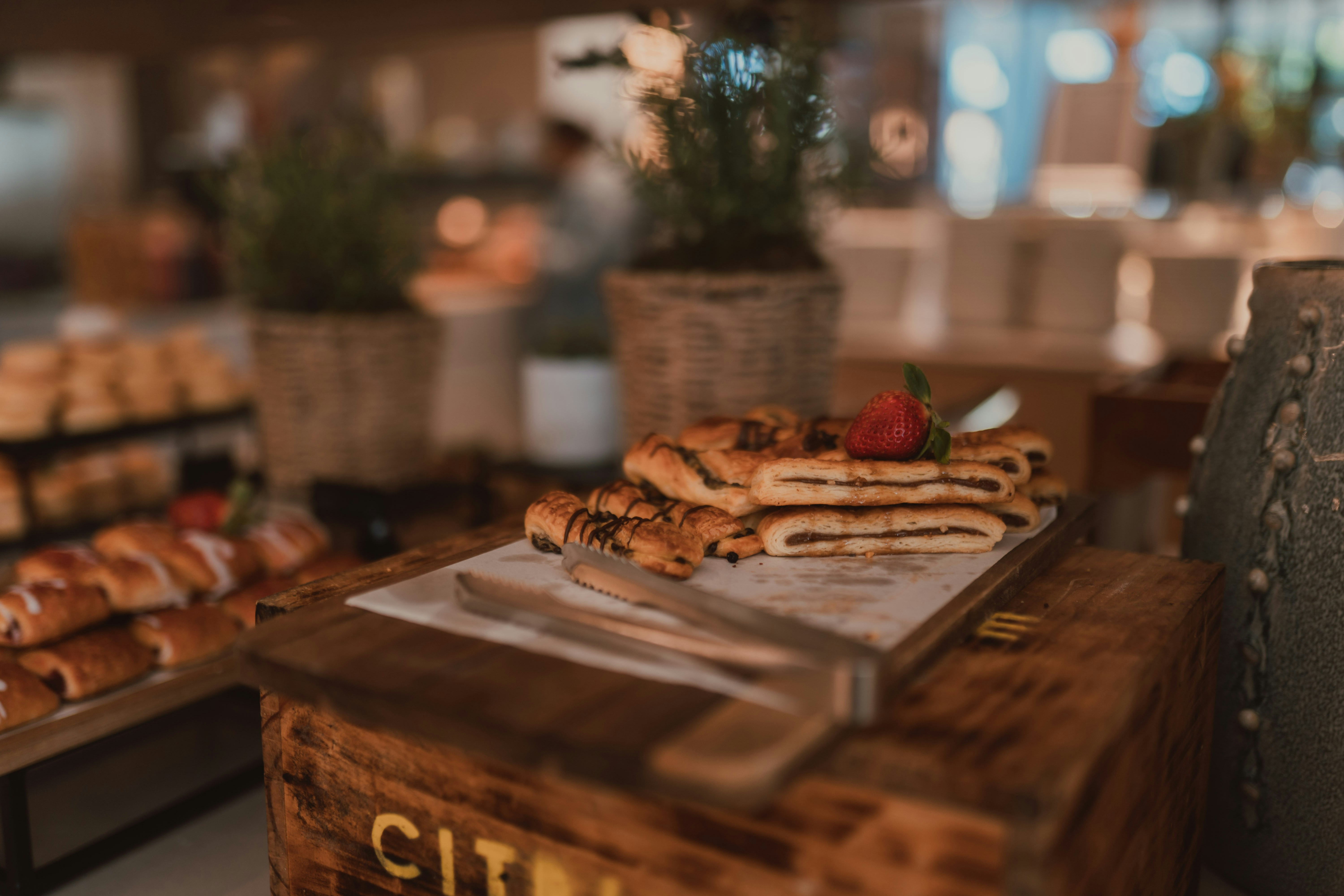 Glazed Pastries On a Wooden Display: Cozy Café Scene