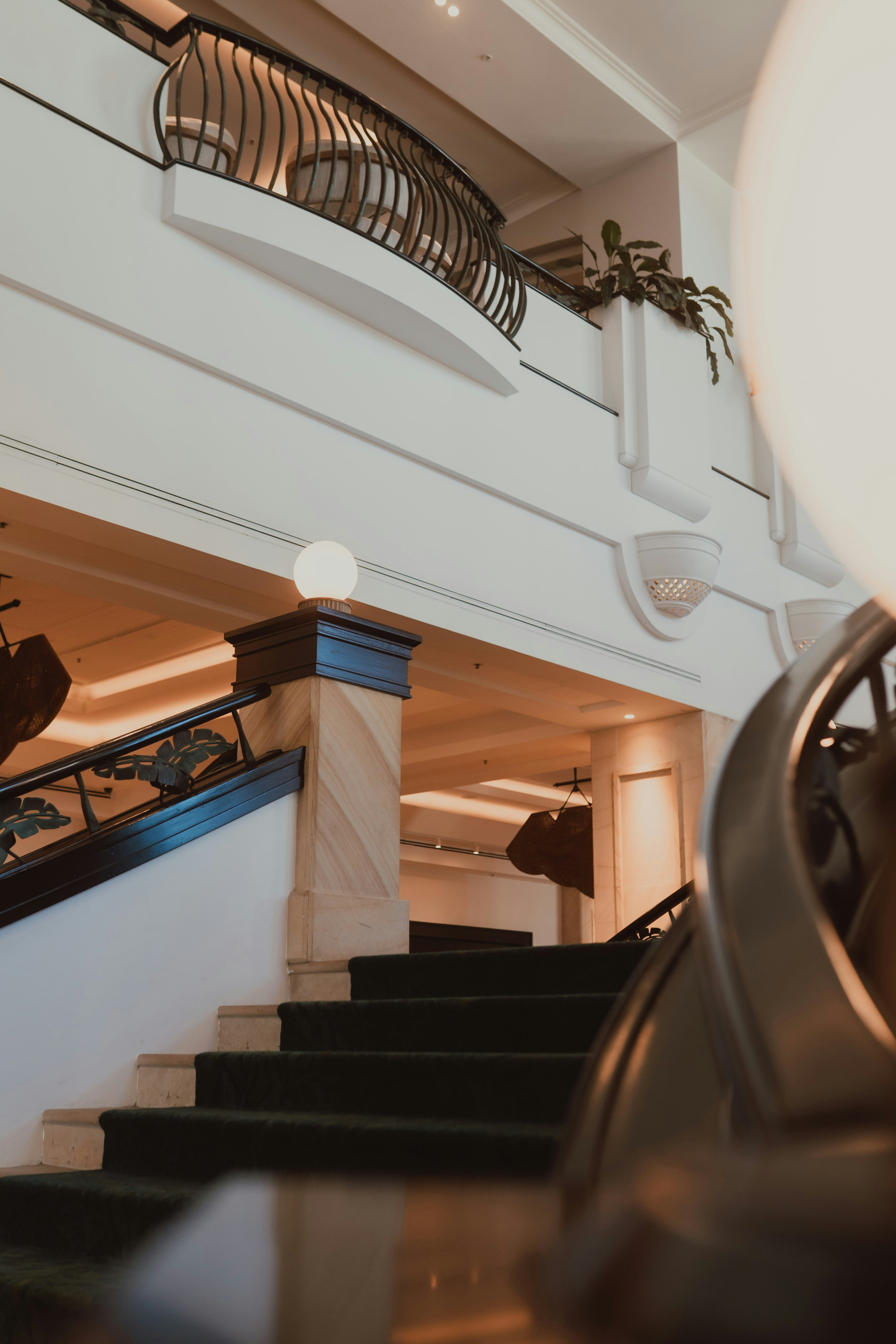 Gentle ascent: ambient light bathes a grand hotel lobby staircase