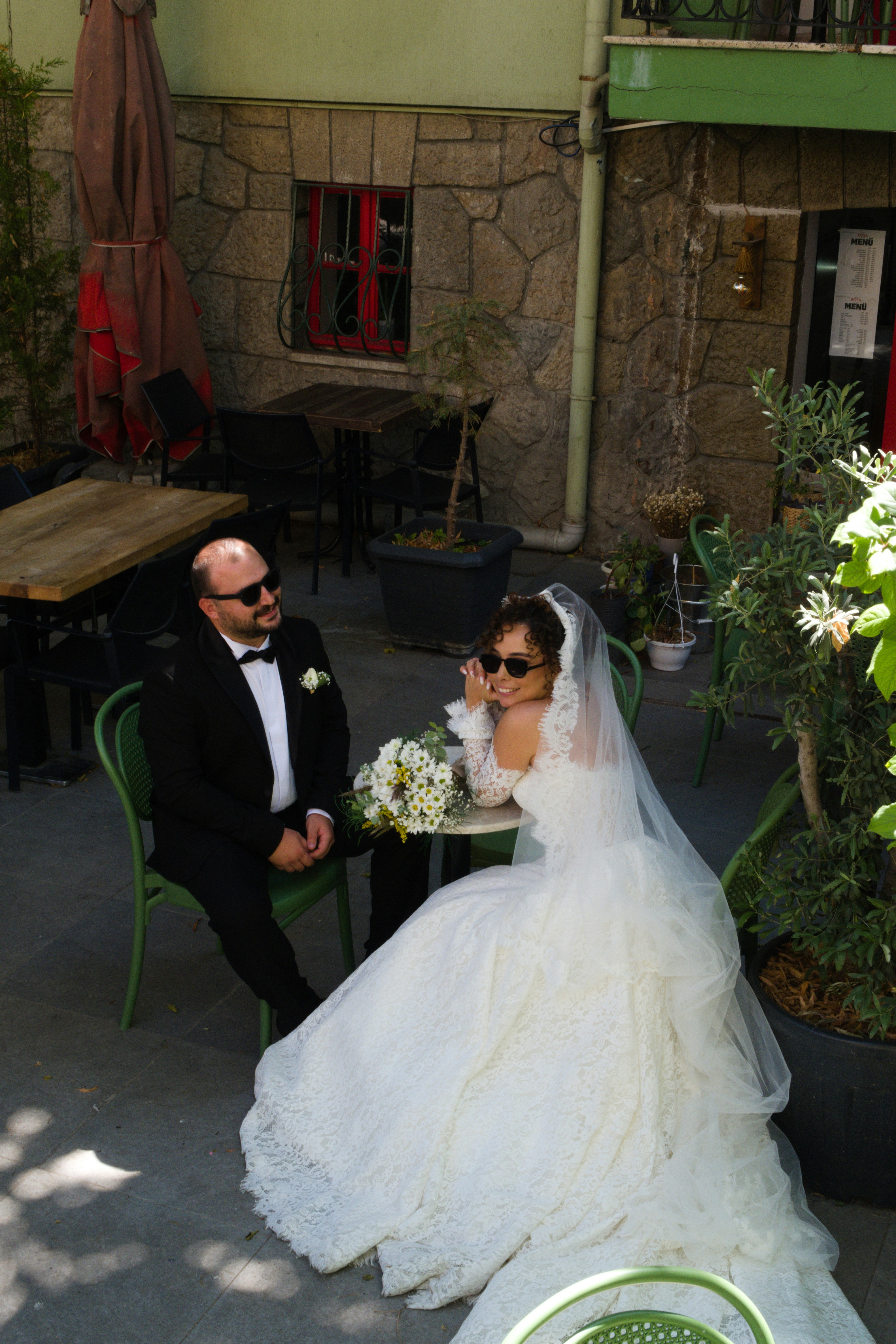 Bride and Groom Share a Quiet Moment in a Sunlit Courtyard