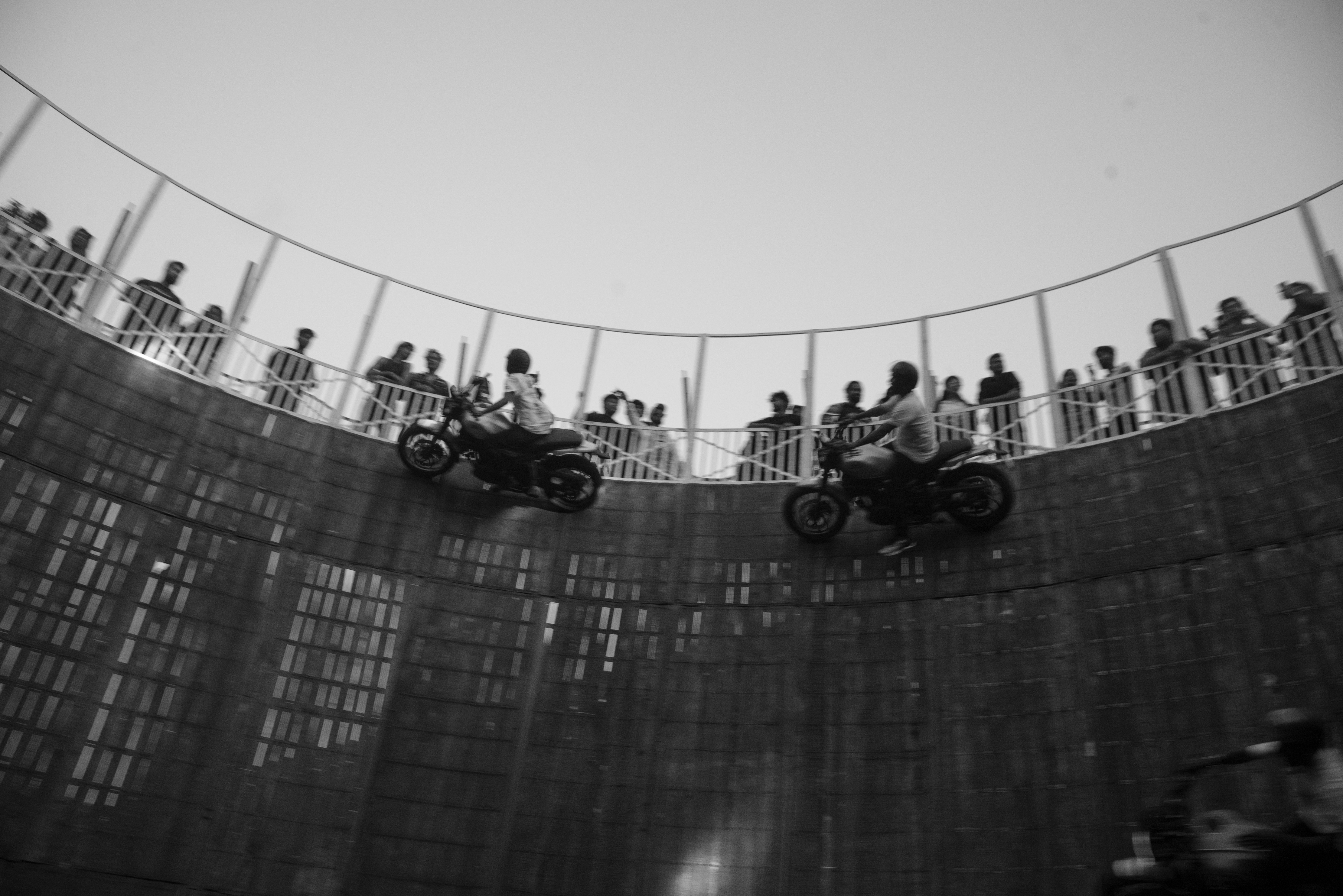 Motorcycle Duel over the Rim: Riders Balance on a Circular Wall