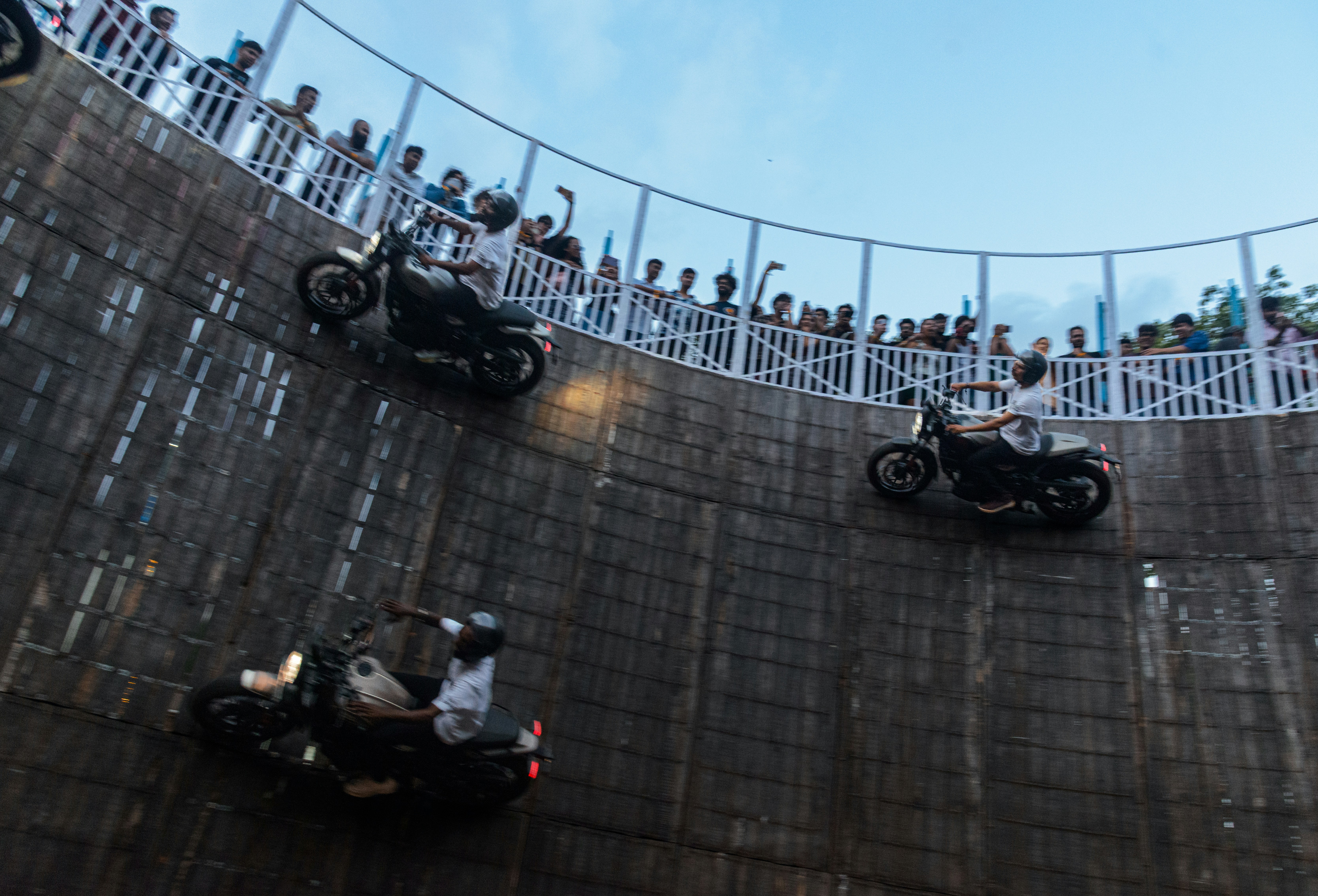 Motorcycle Ascent on a Curve: Crowd Witnesses the Vertical Drift