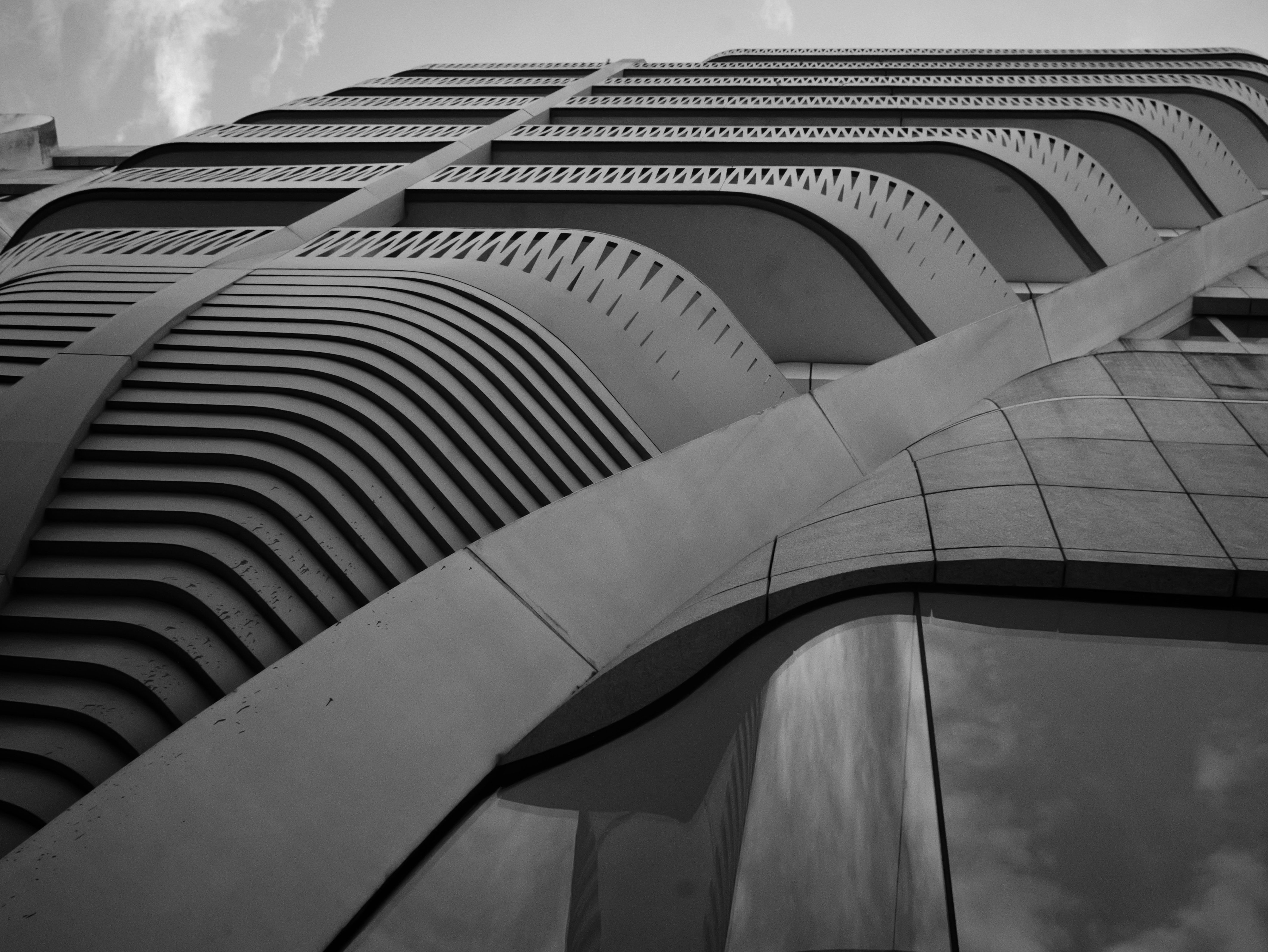 Ribbed Facade Echo: A Concrete Dance Along Curved Strata