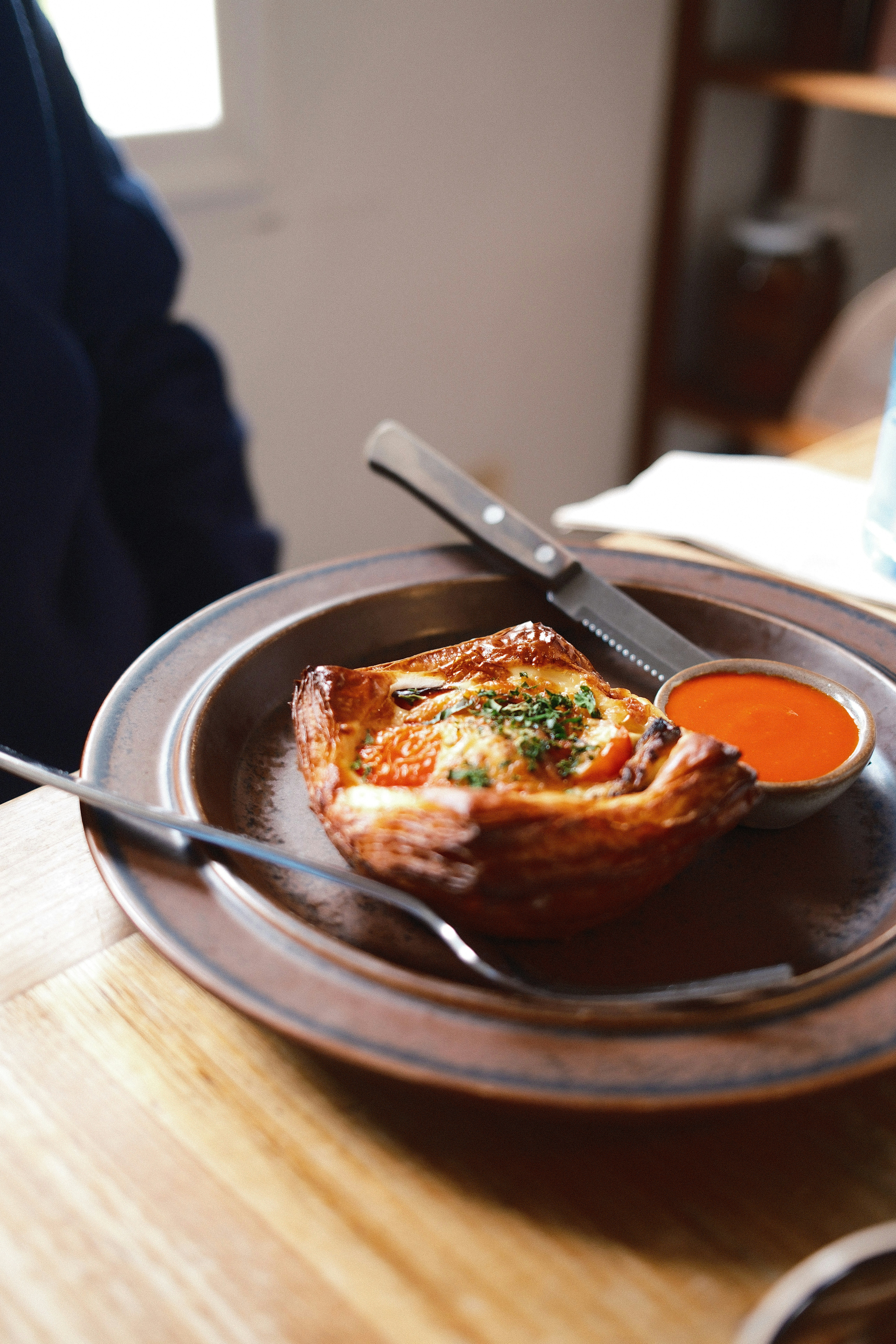 Golden Pastry Nest: Poultry Pie with Dipping Sauce on Rustic Plate
