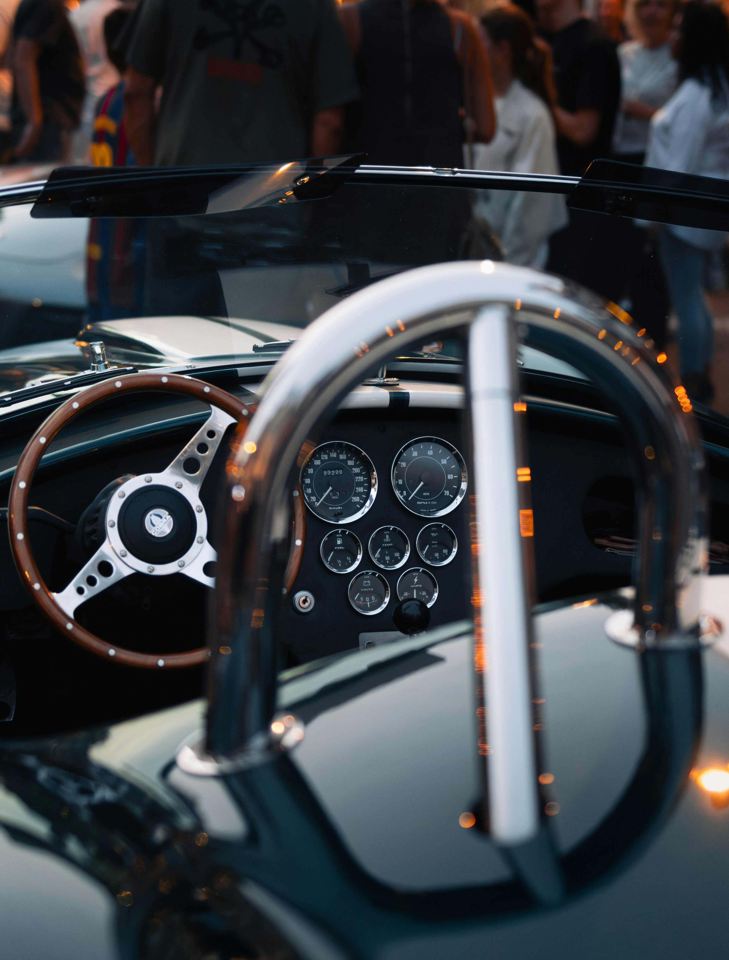 Cockpit Reflections: A Classic Car Dashboard Framed by Barrelling Chrome