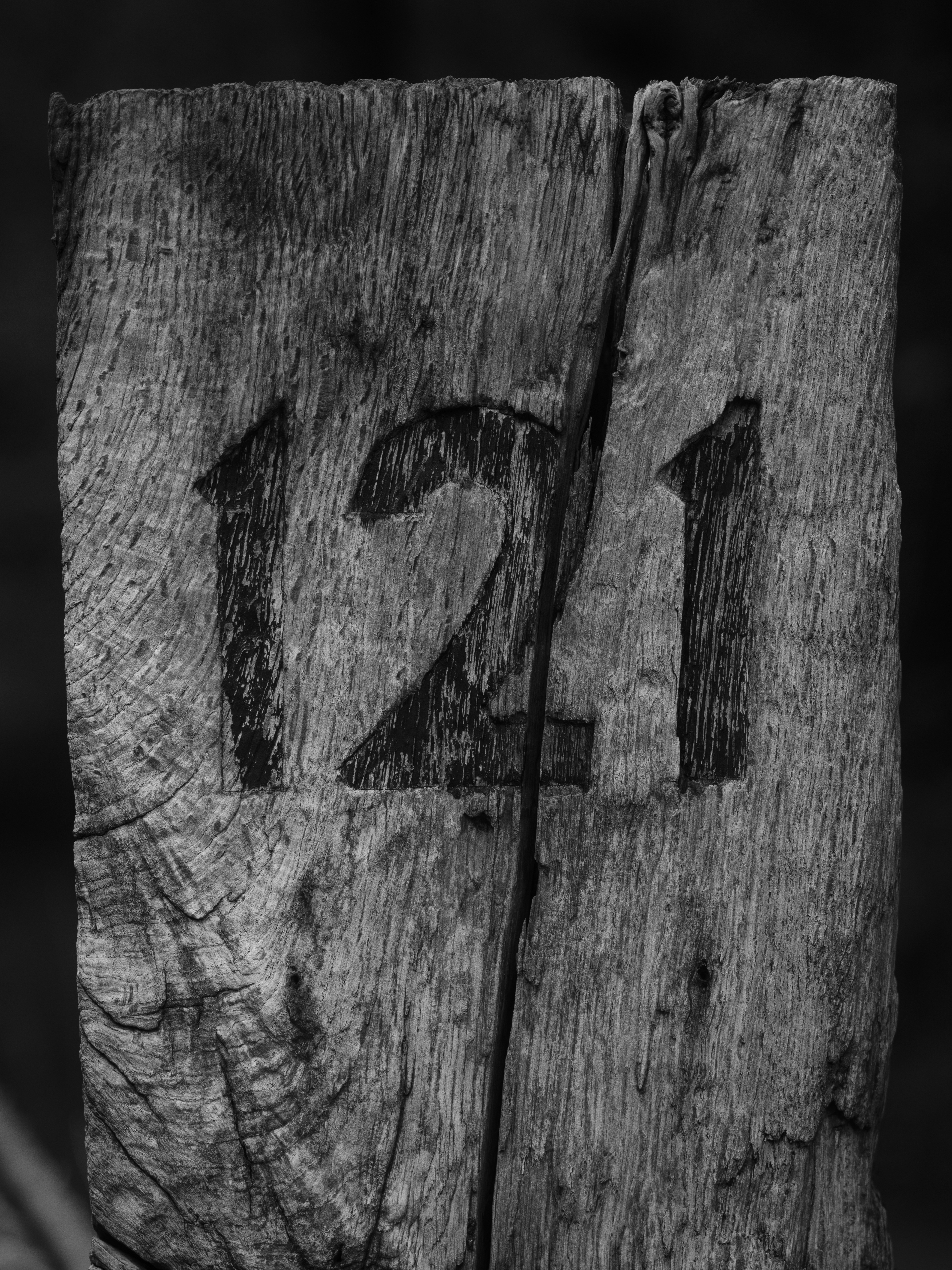 Weathered Wood Exit Sign: The Number 21 Carved in Time