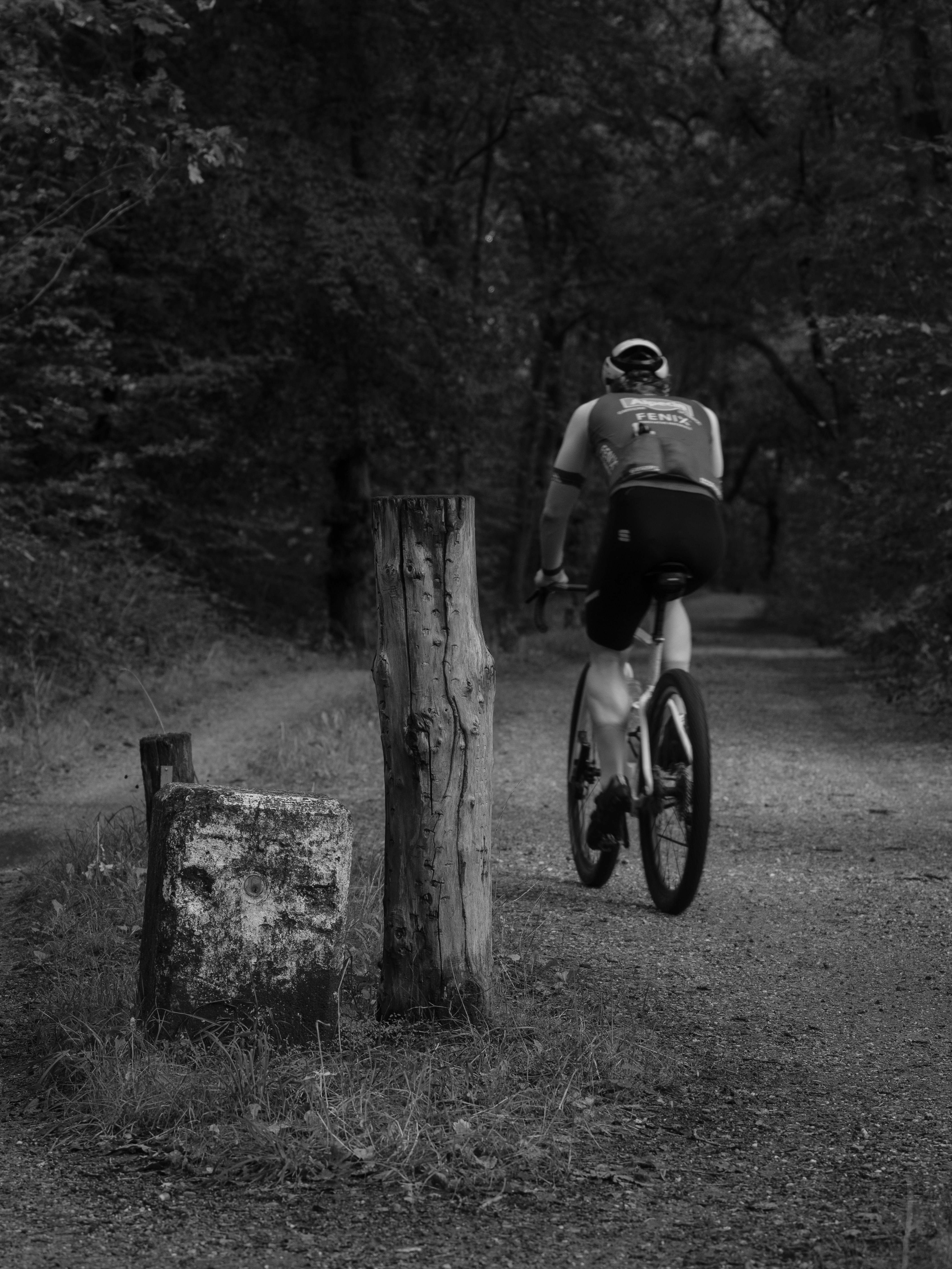 Mid-Route Rider: Focused Ascent on a Gravel Path