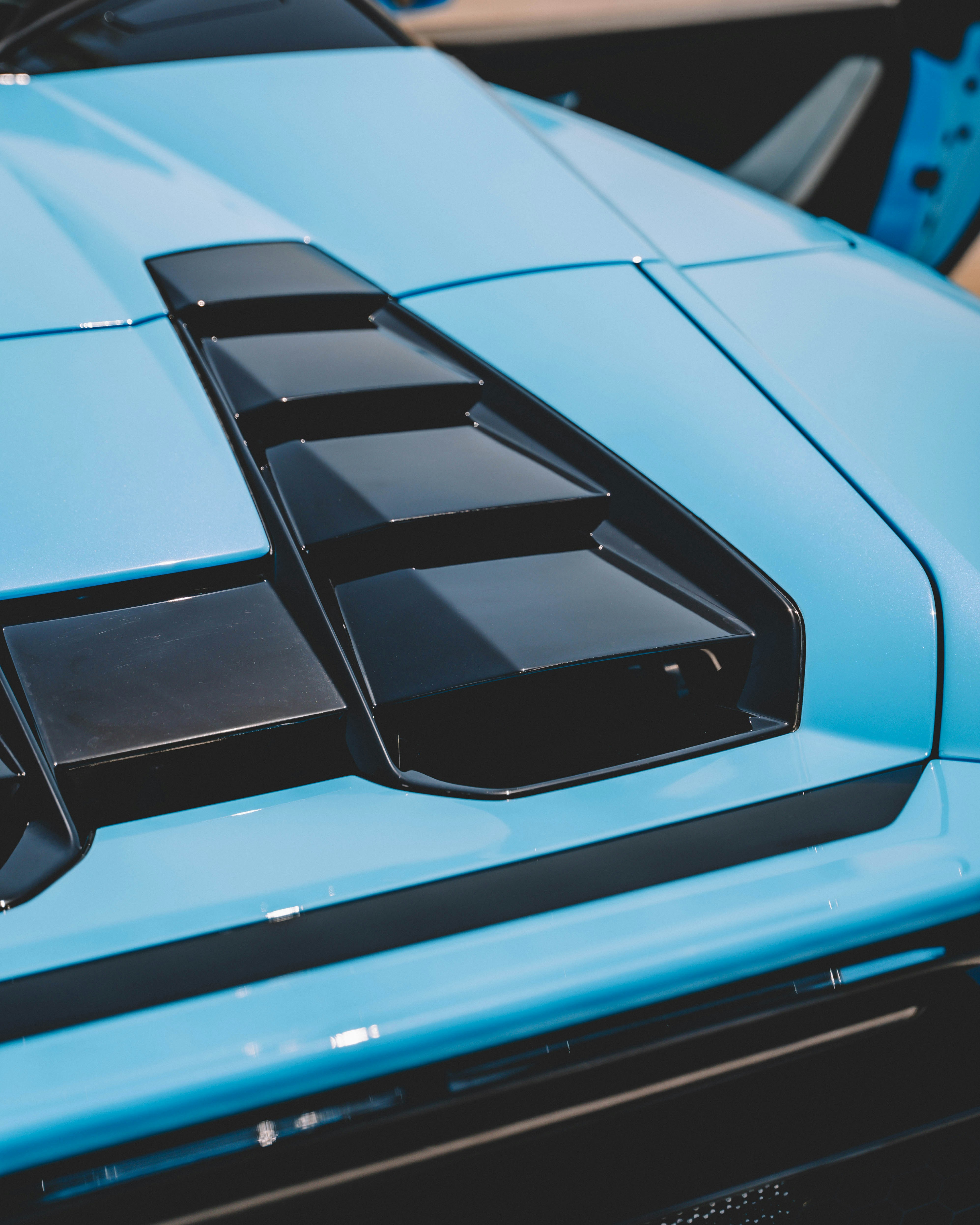 Aqua Veloce: Blue Power Lines Across the Hood
