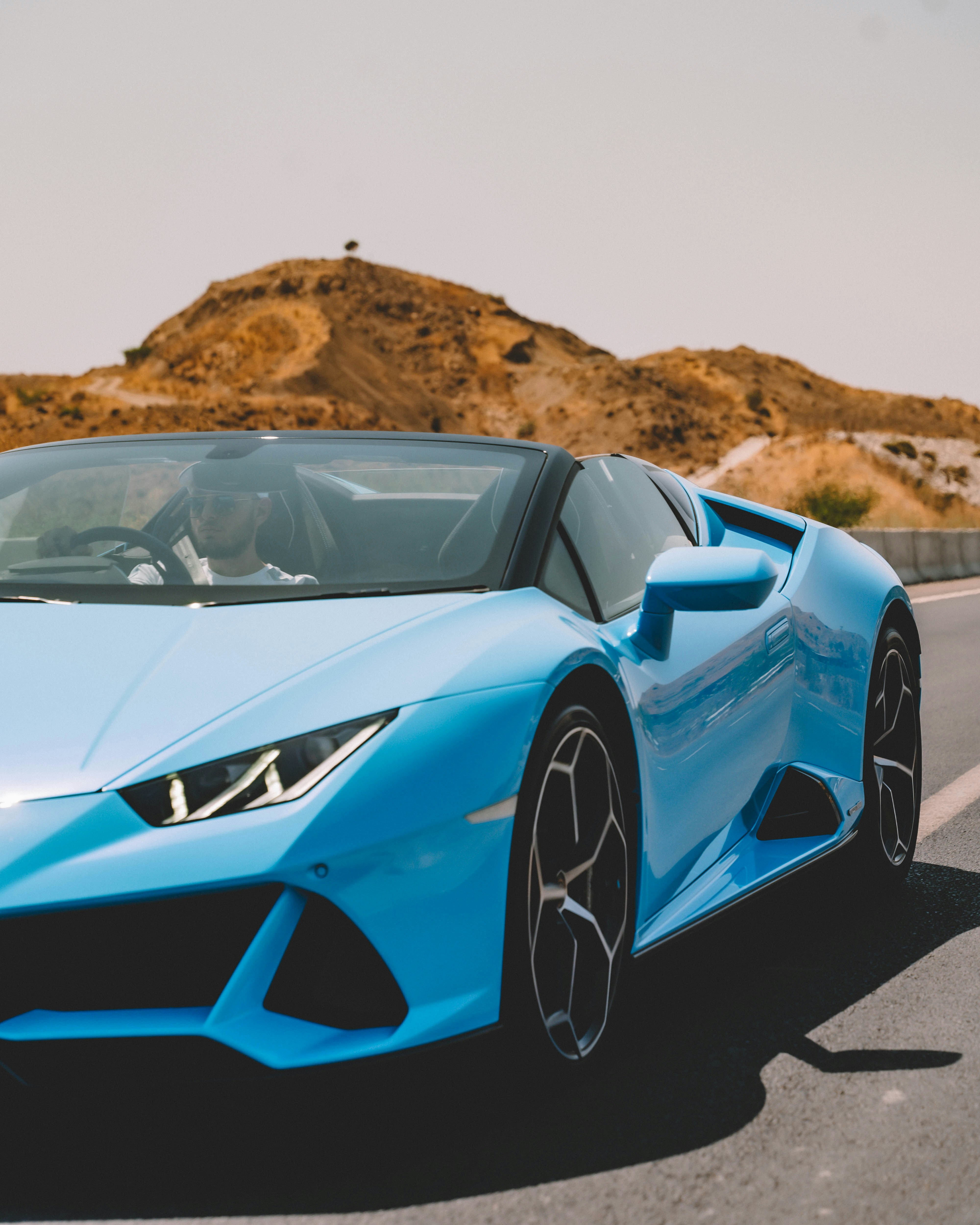 Azure thunder: a blue Lamborghini prowls a desert highway