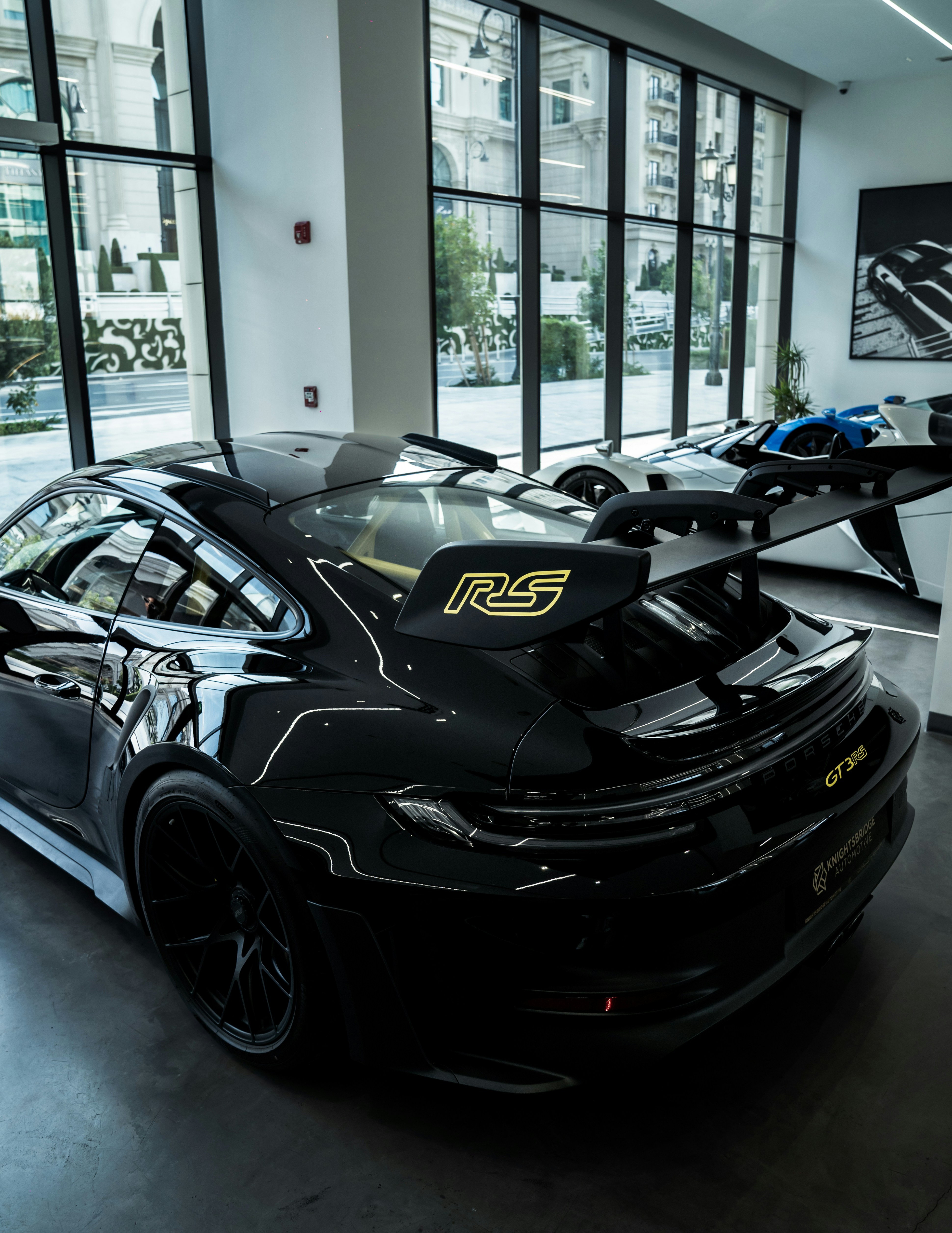 Rear wing badge and glossy silhouette: a showroom Porsche lineup