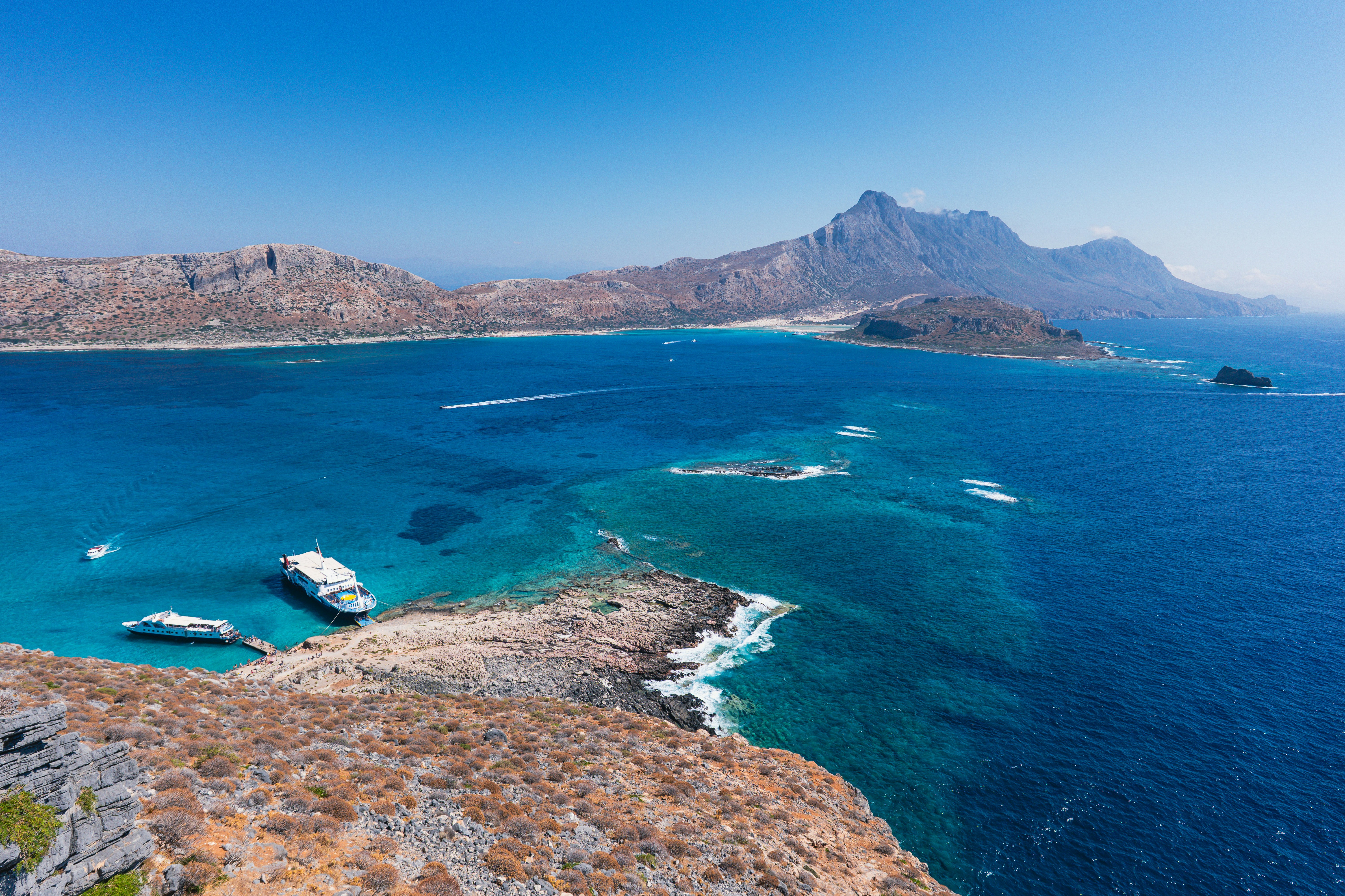 Azure Coastline Convergence: Boats at the Edge of a Mediterranean Panorama