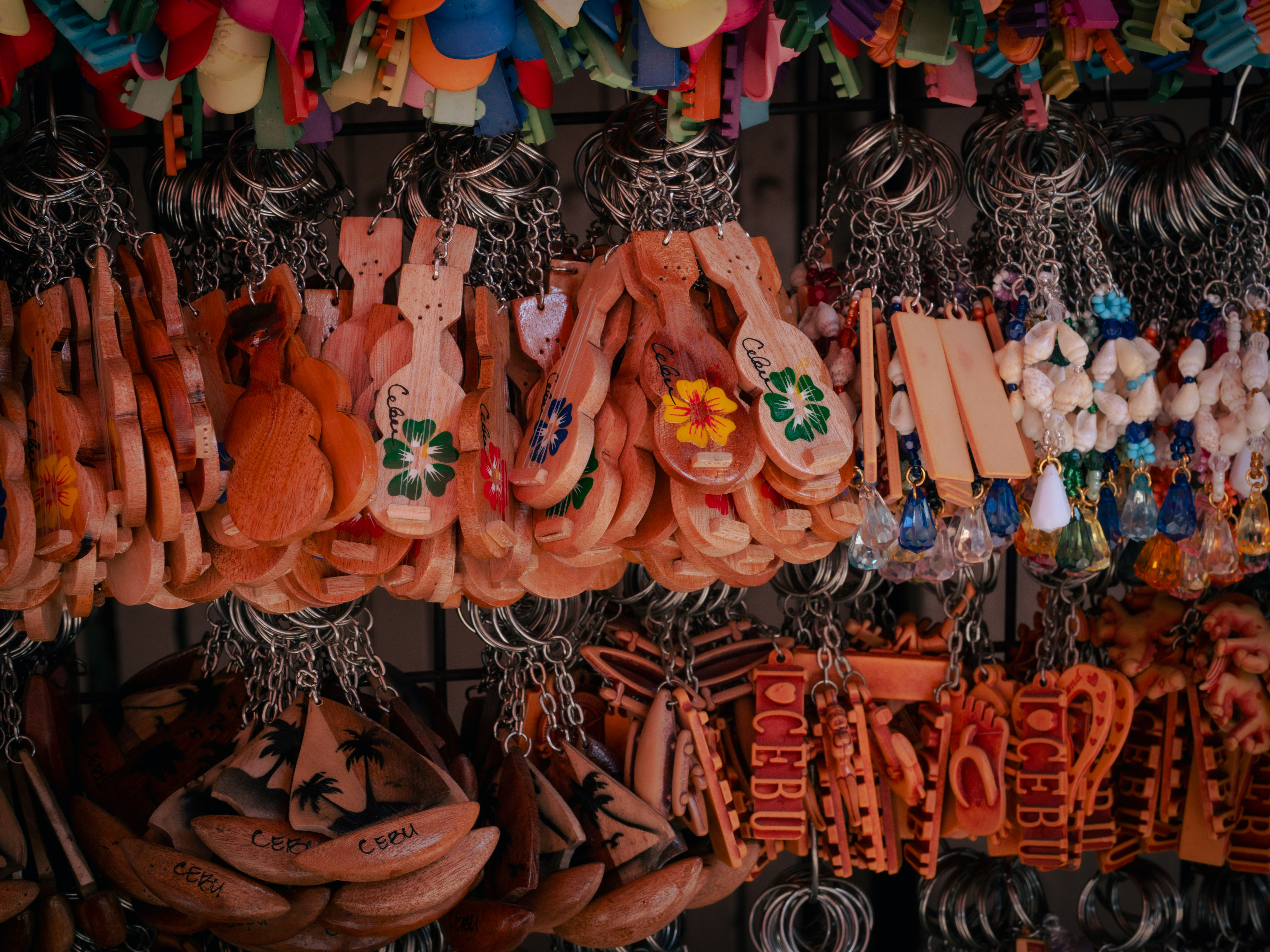 Colorful Trinkets on a Market Stall: Wooden Shapes and Keychains
