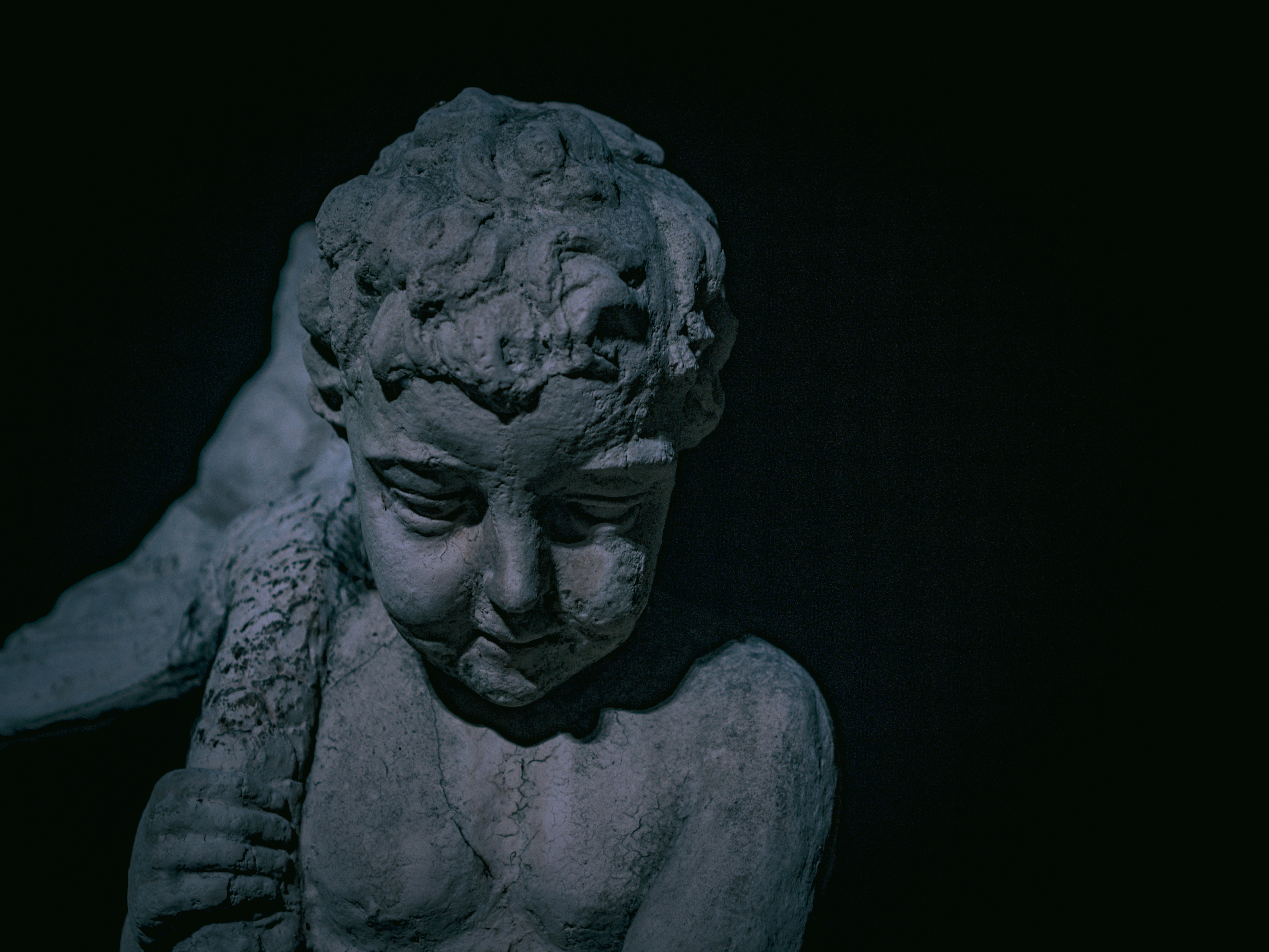 Moonlit Cherub: A Serene Marble Child in Shadow