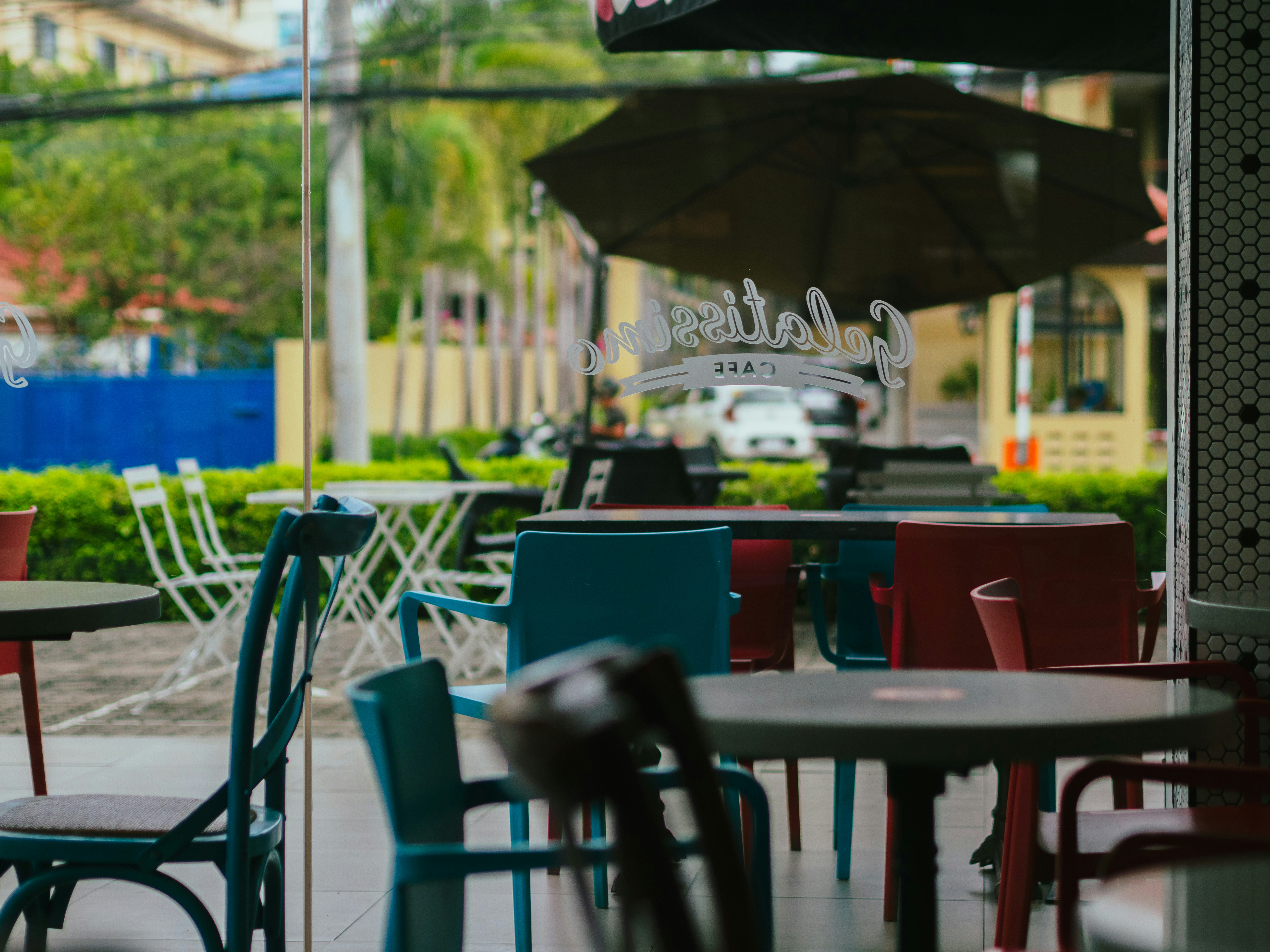 Quiet Cafe Scene Through Glass: Chairs and Tables in Soft Focus
