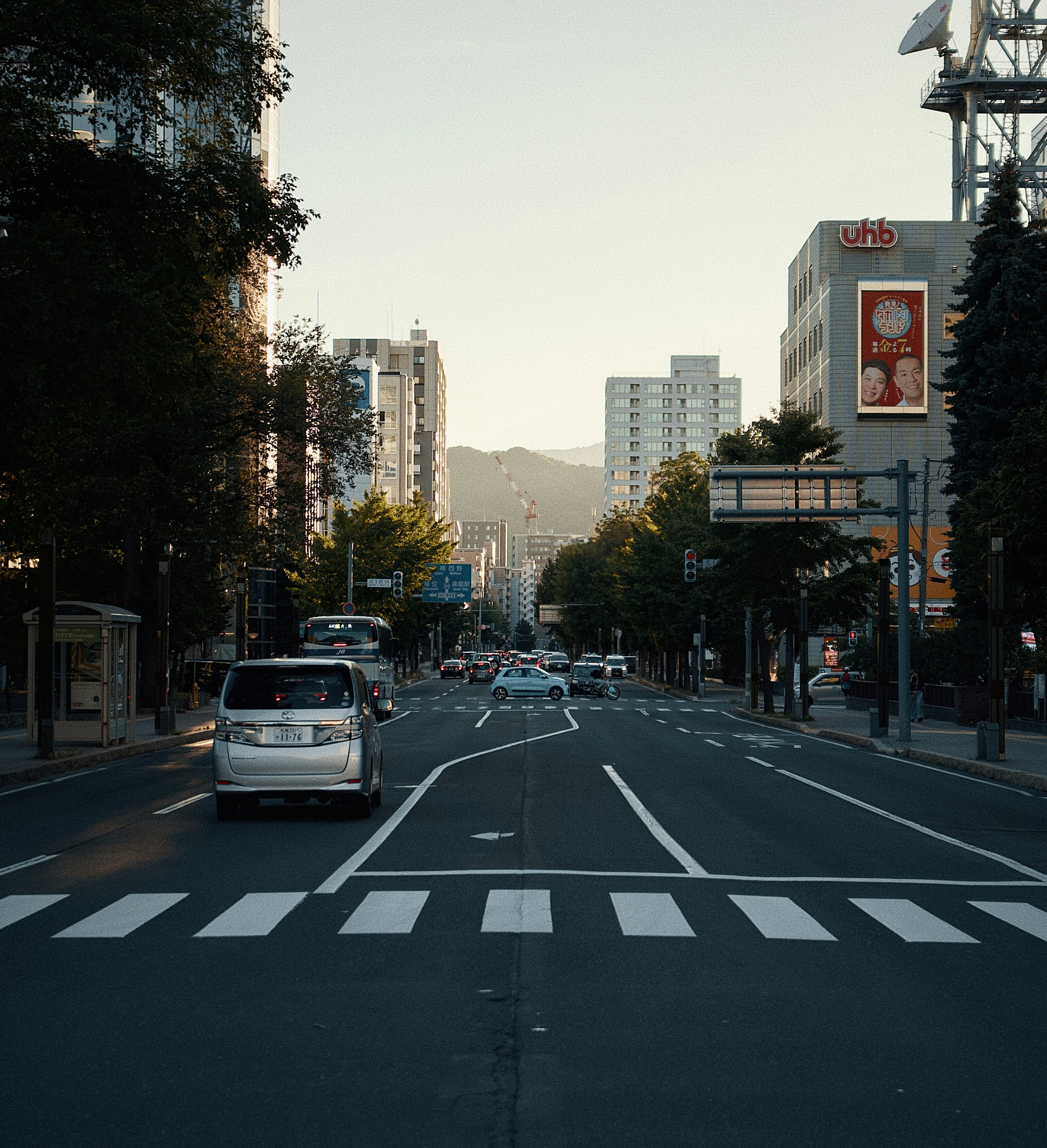 City Street Convergence: Cars, Crosswalks, and Distant Hills