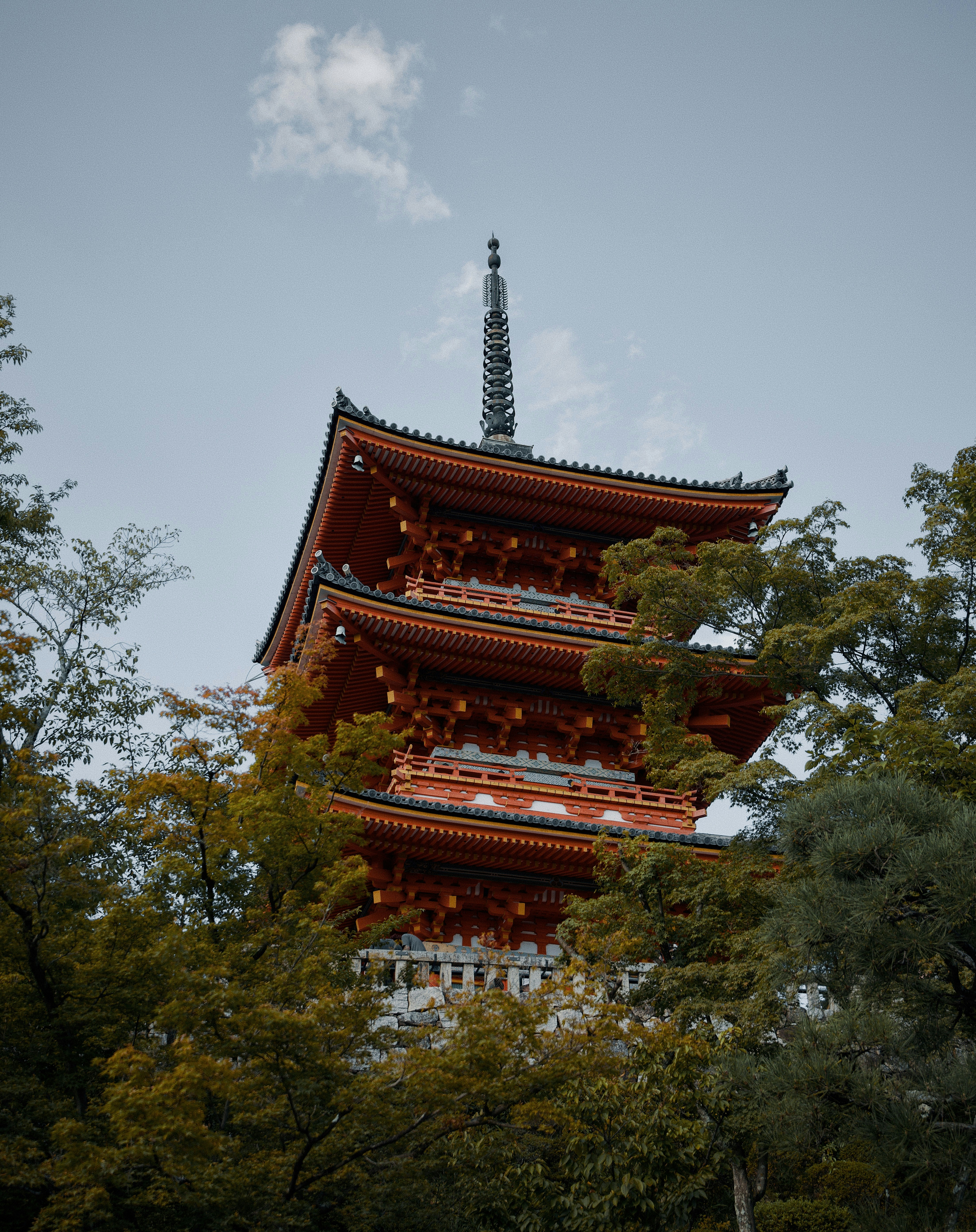 Crimson Pagoda Rising Through Autumn Leaves