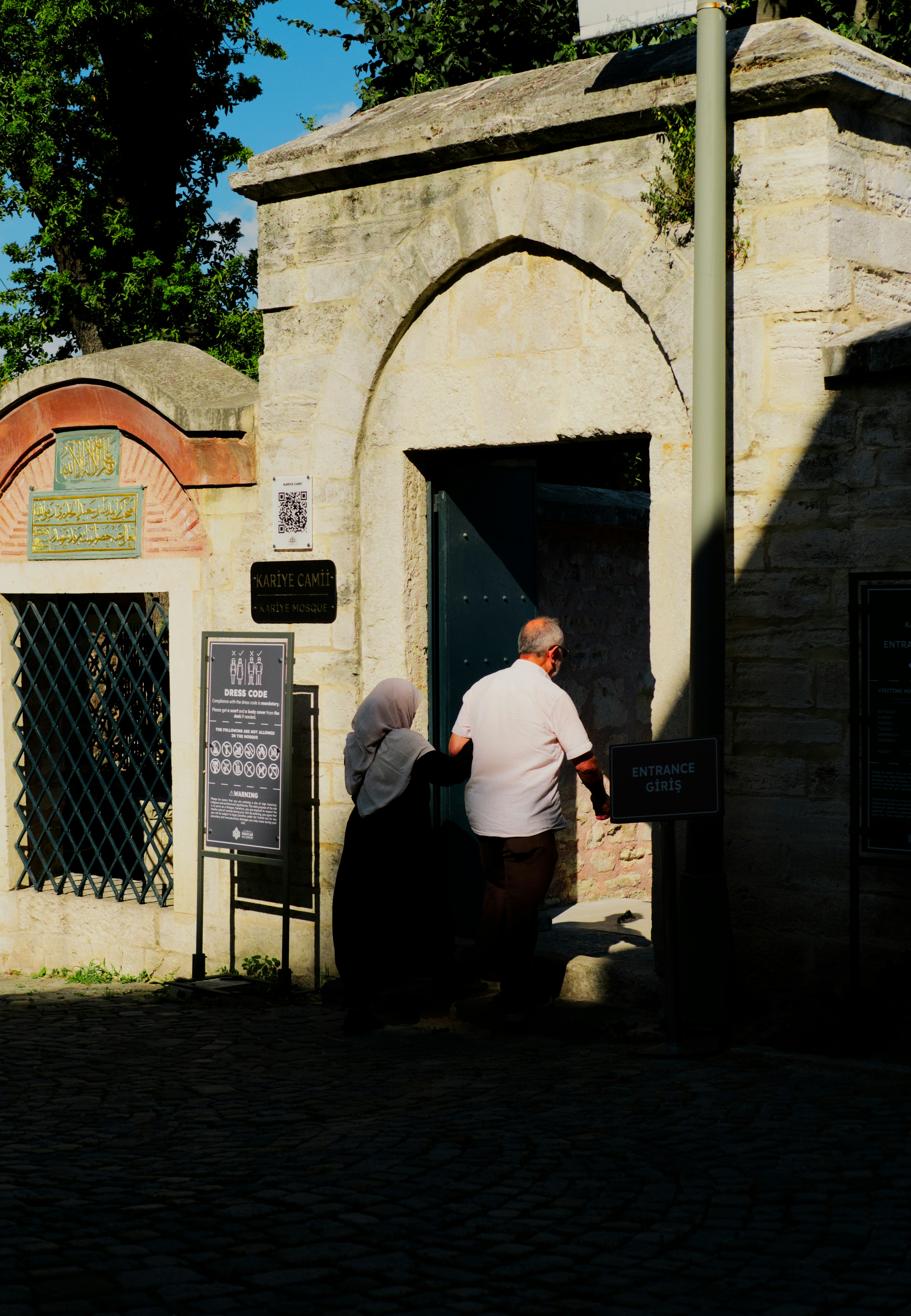 Passing Through the Arch into Shadowed Courtyard