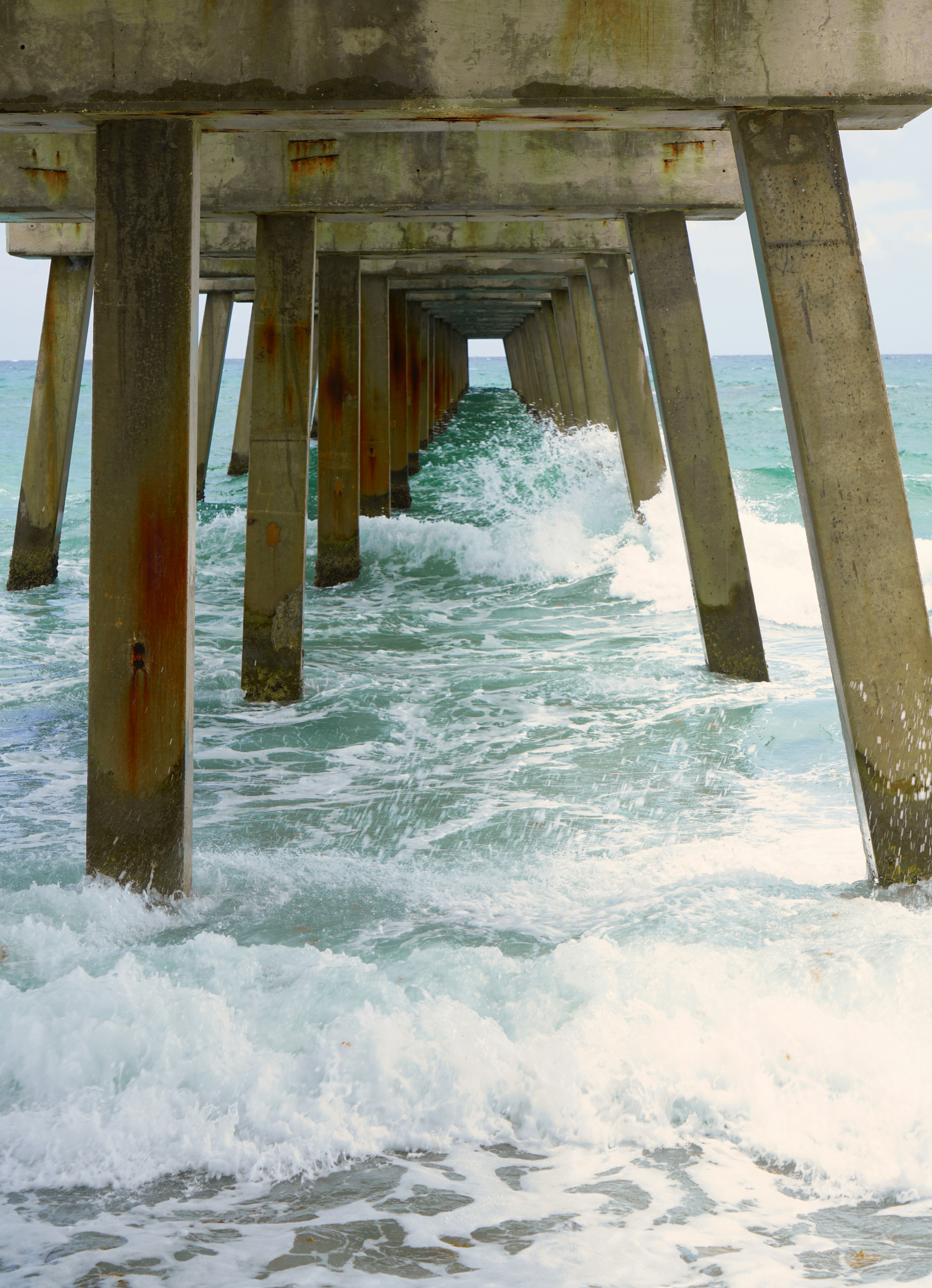 Pier Beneath the Tide: A Linear View Through Weathered Columns