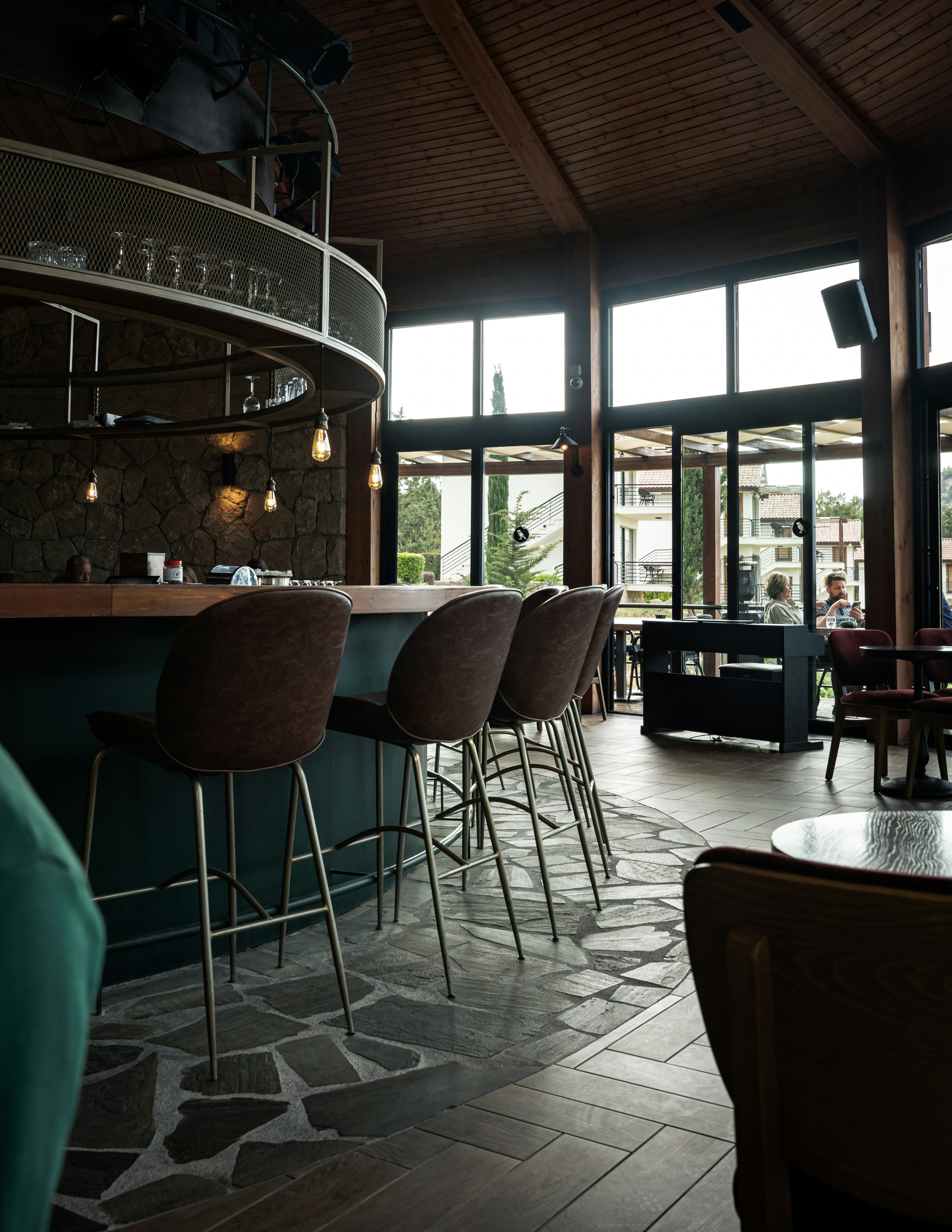 Curved Balcony Bar Under Warm Globe Lights