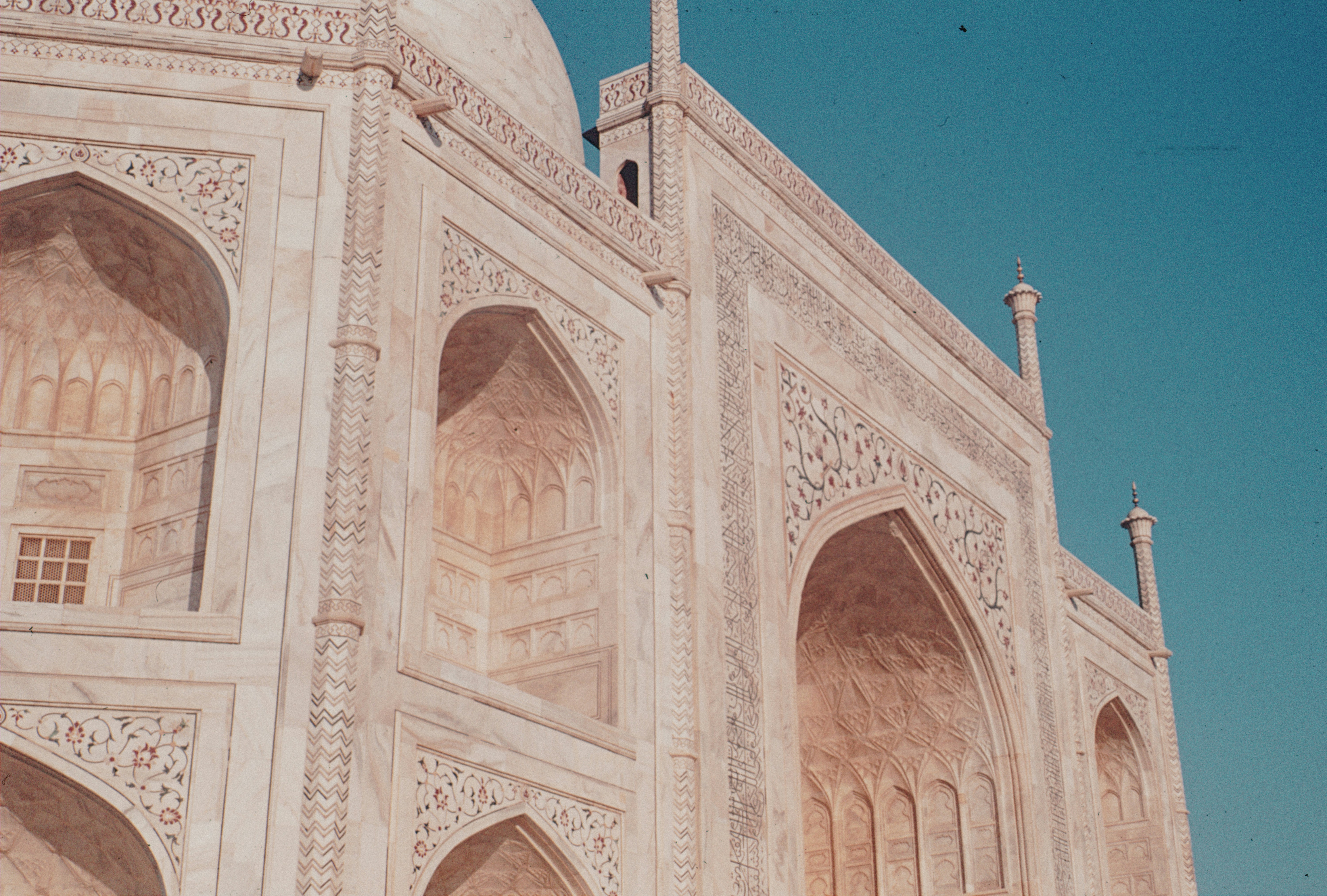 Intricate marble arches under a clear blue sky