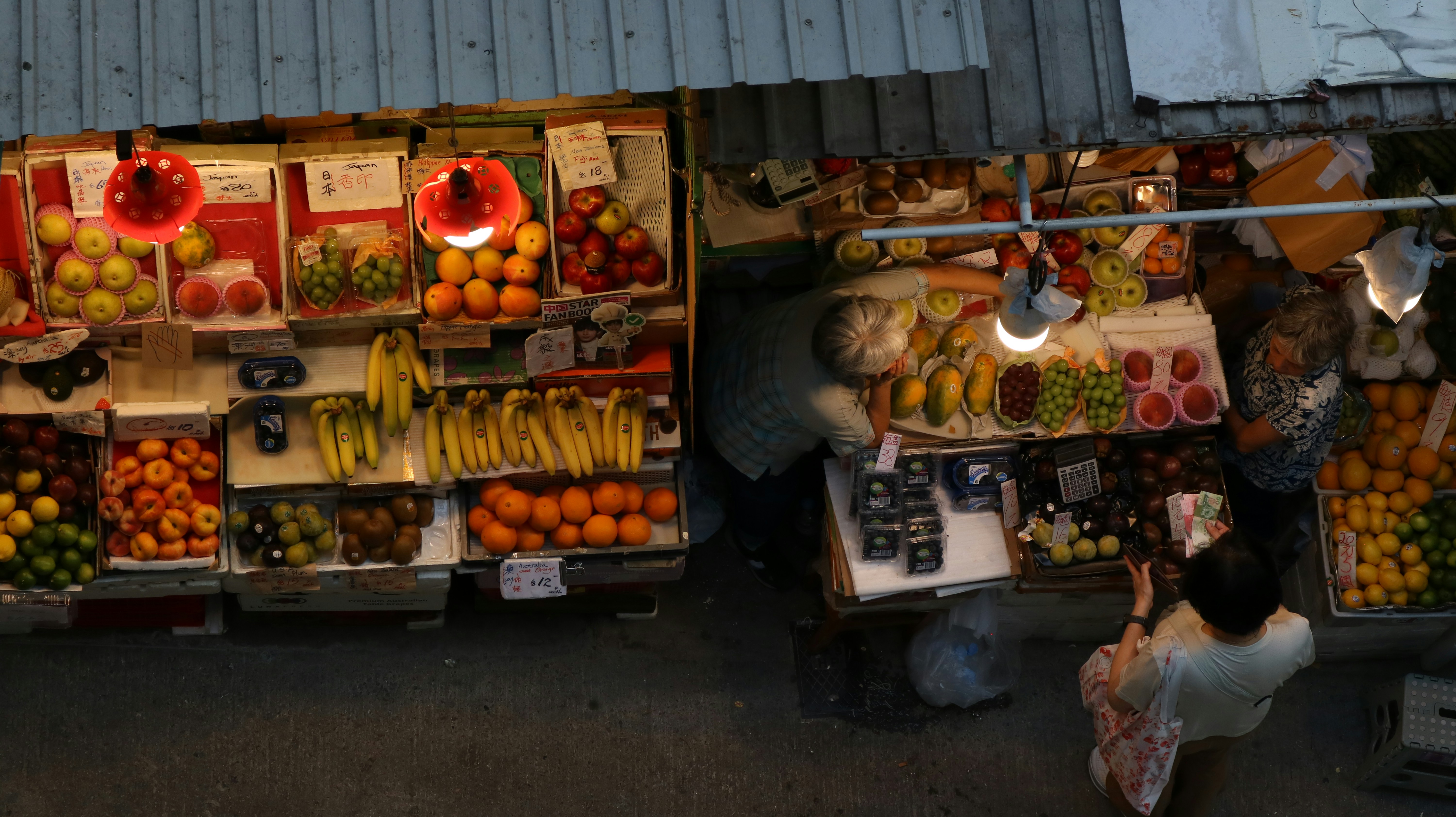 Aerial market mosaic: fruit stalls in a bustling urban row