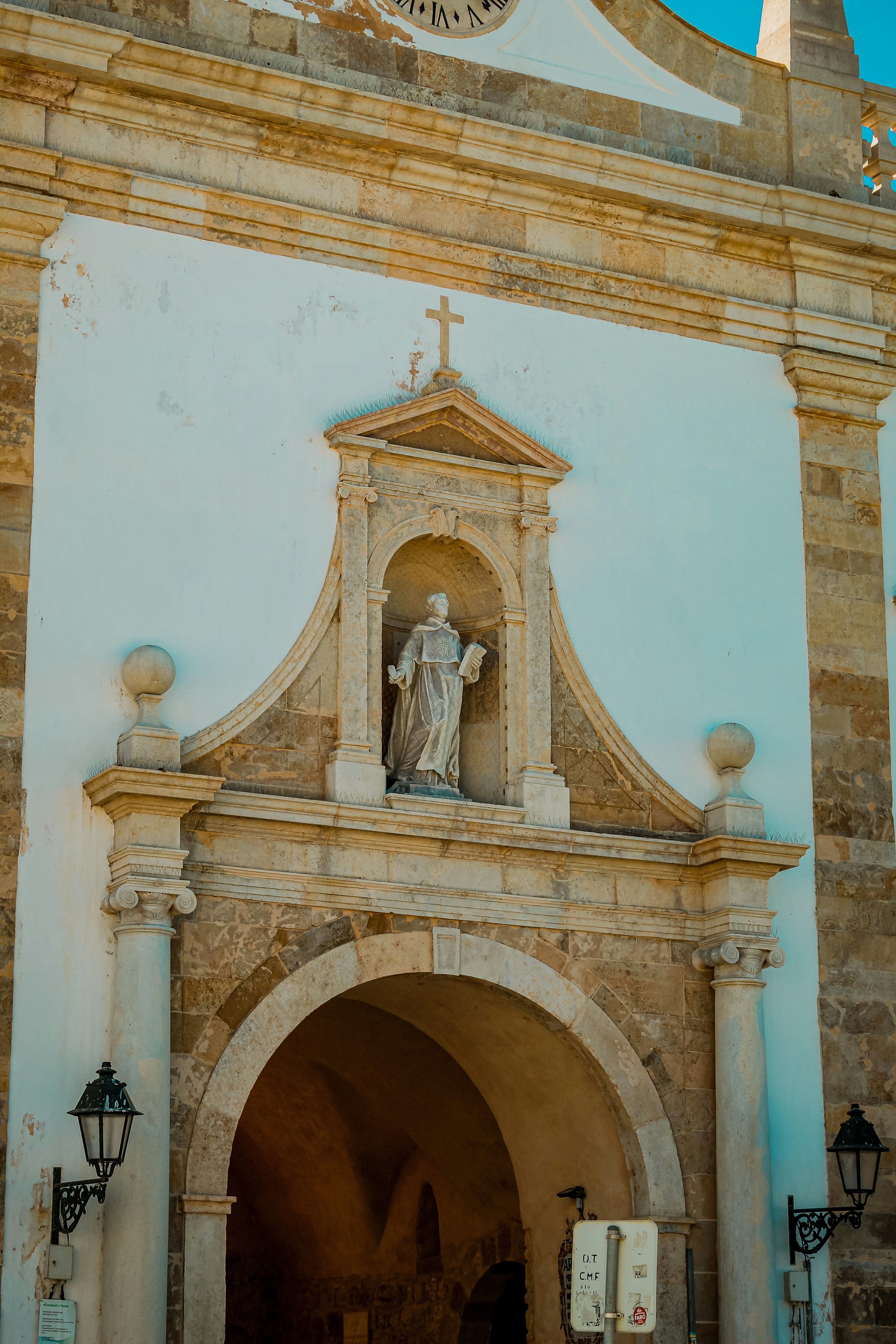 Colonial Church Facade with Central Archway and Statue
