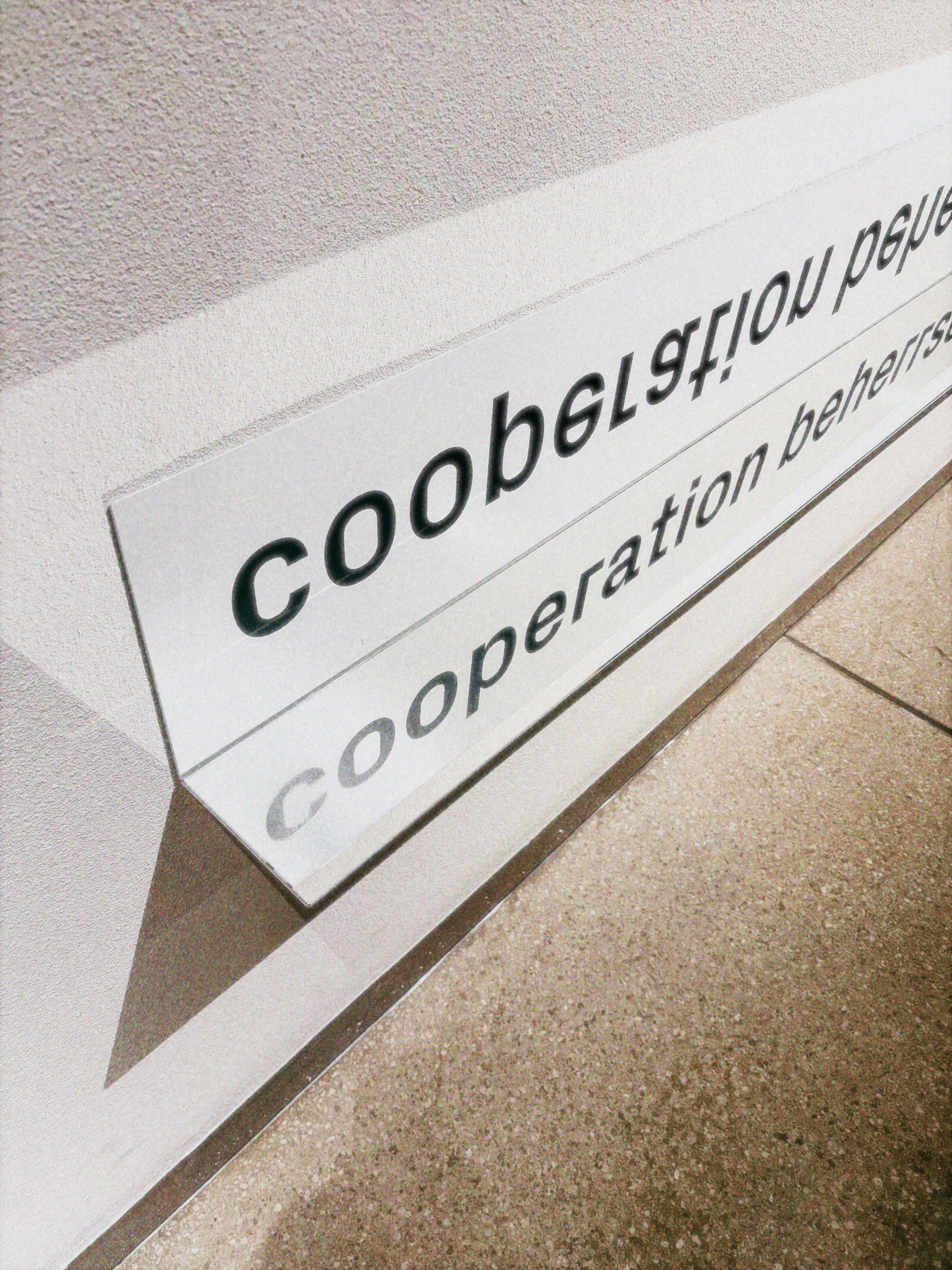 Slanted Signage on a Textured Wall