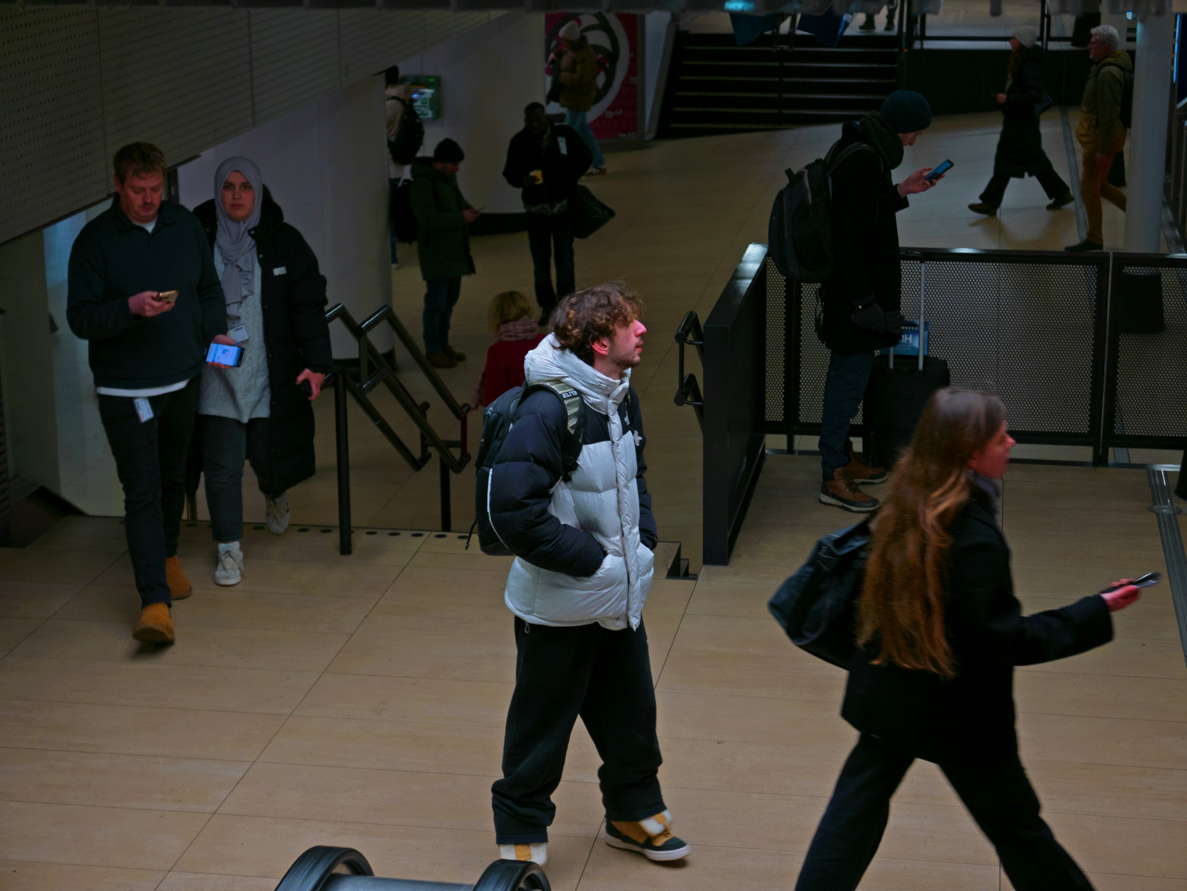 Mid-stride Traveler in a Busy Transit Atrium