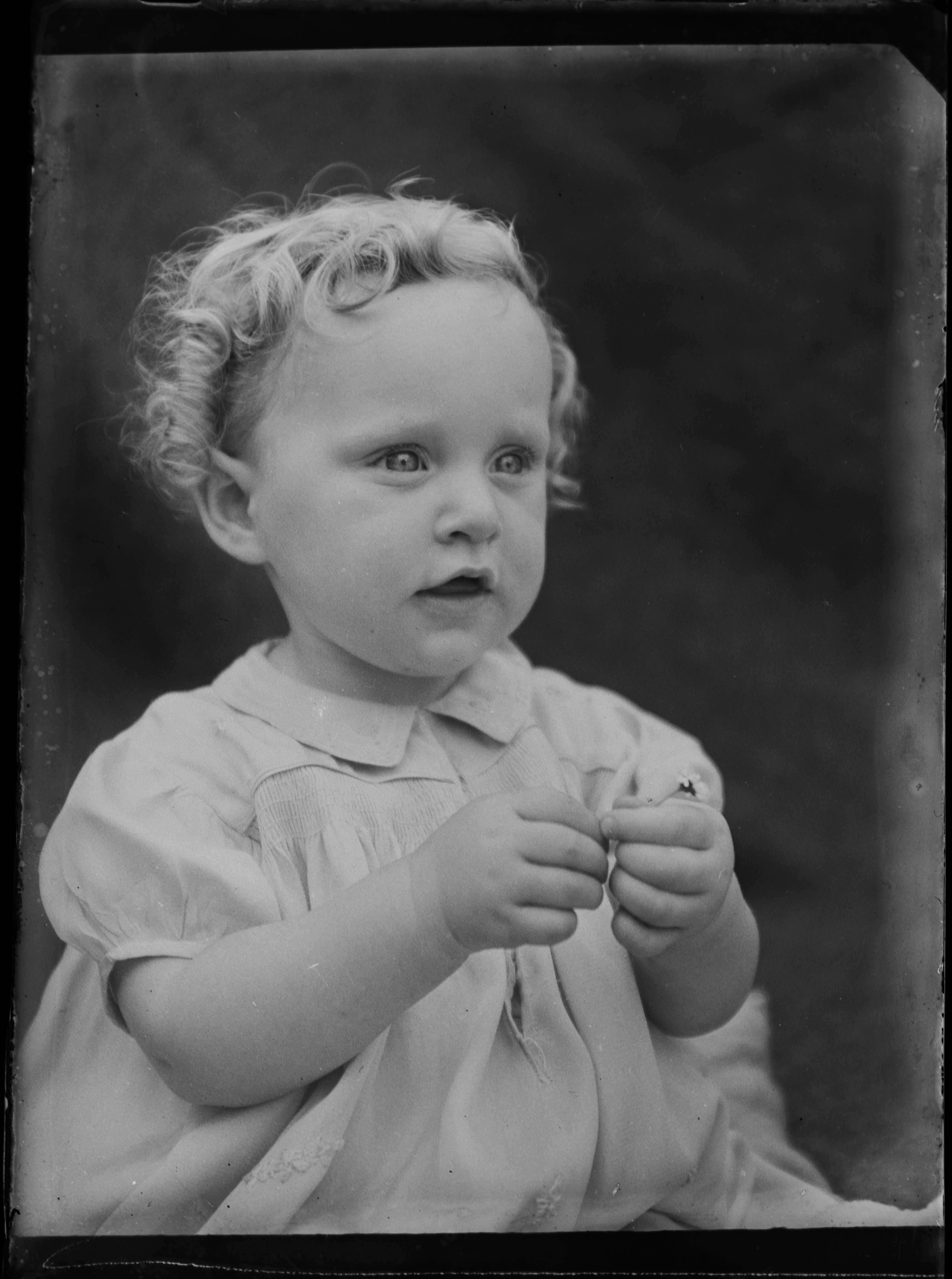 Curious Moment: A Toddler with a Tiny Keepsake