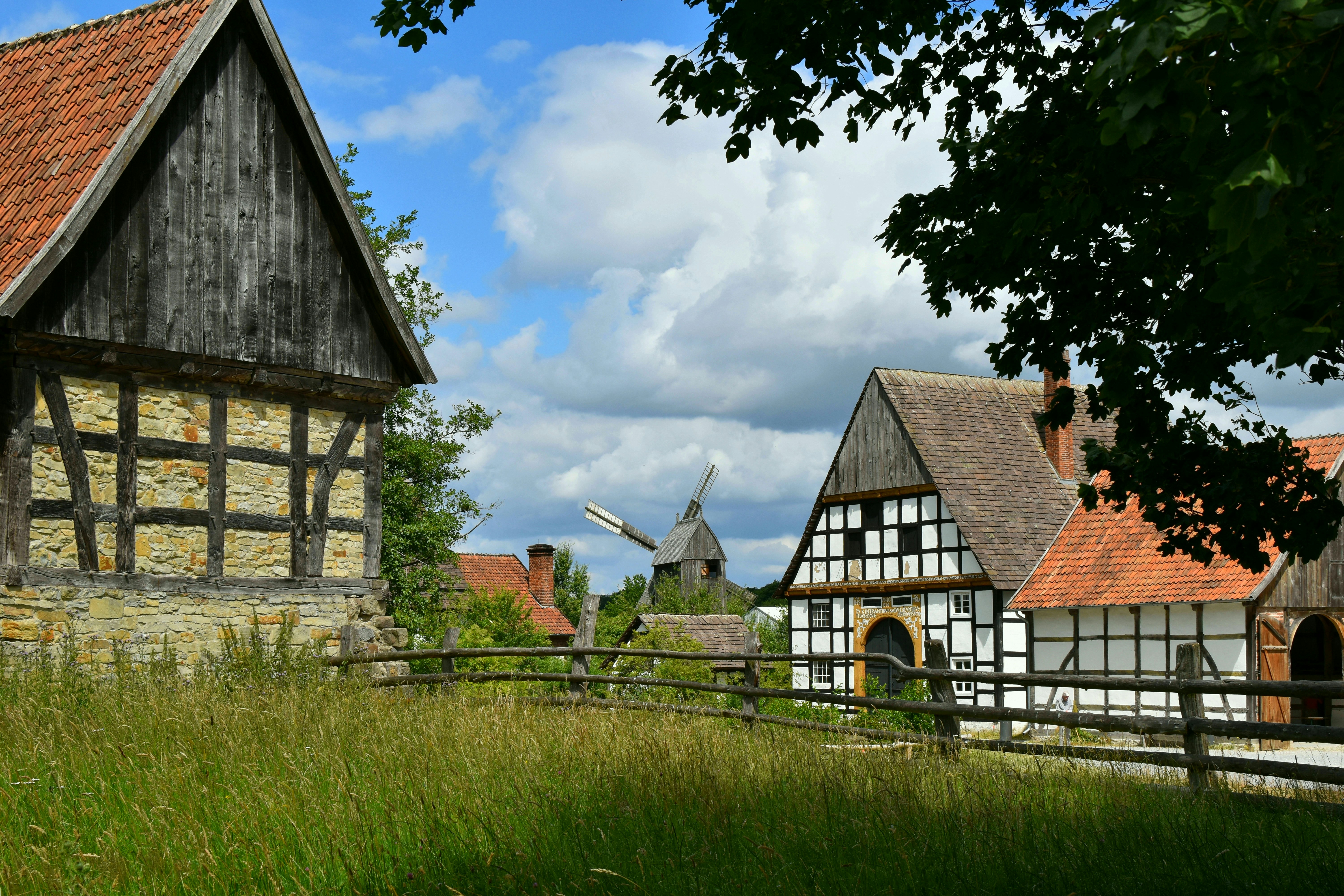 Windmill in a timber-framed village under a bright summer sky