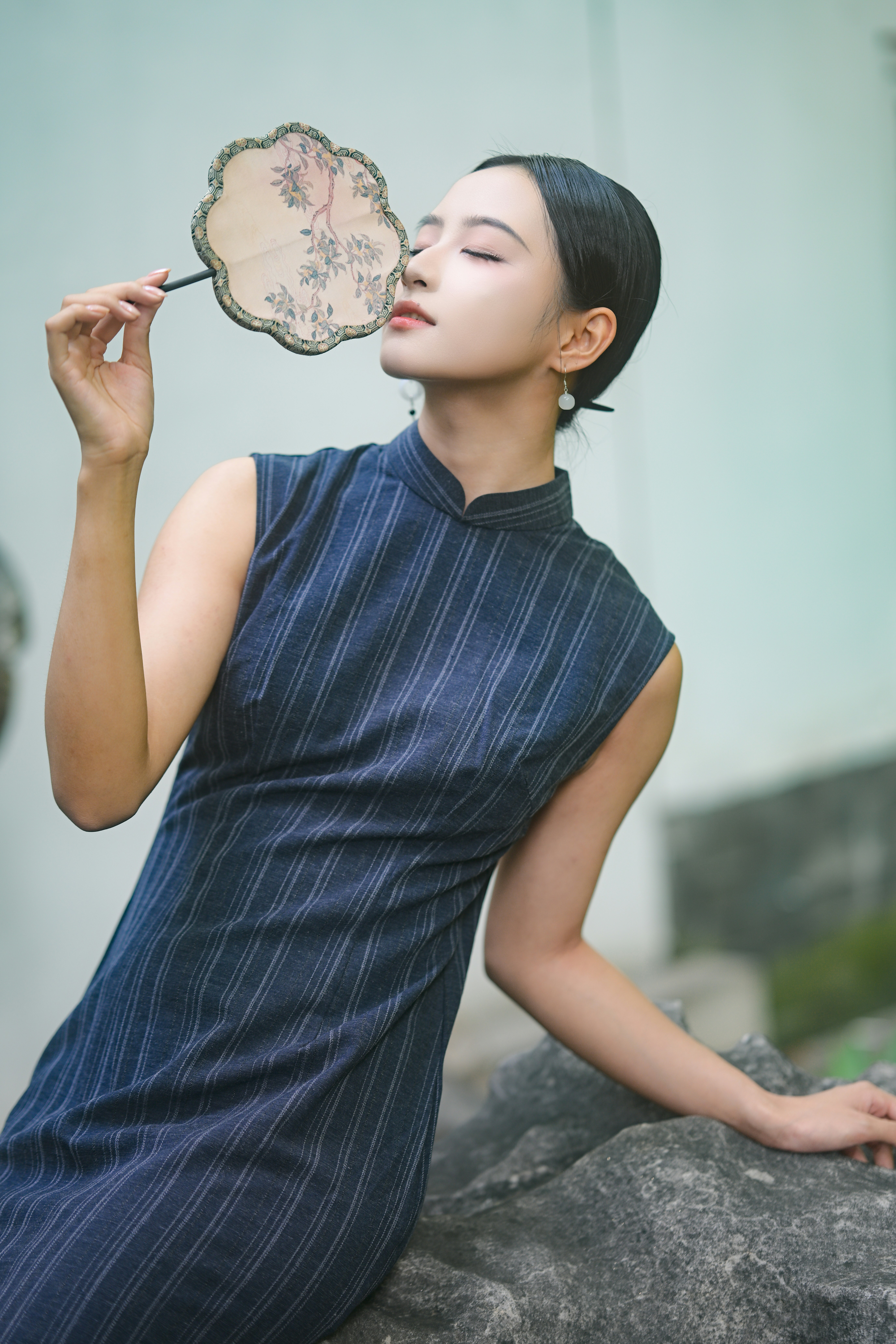 Elegant silhouette: a painterly veil of secrets from a fan