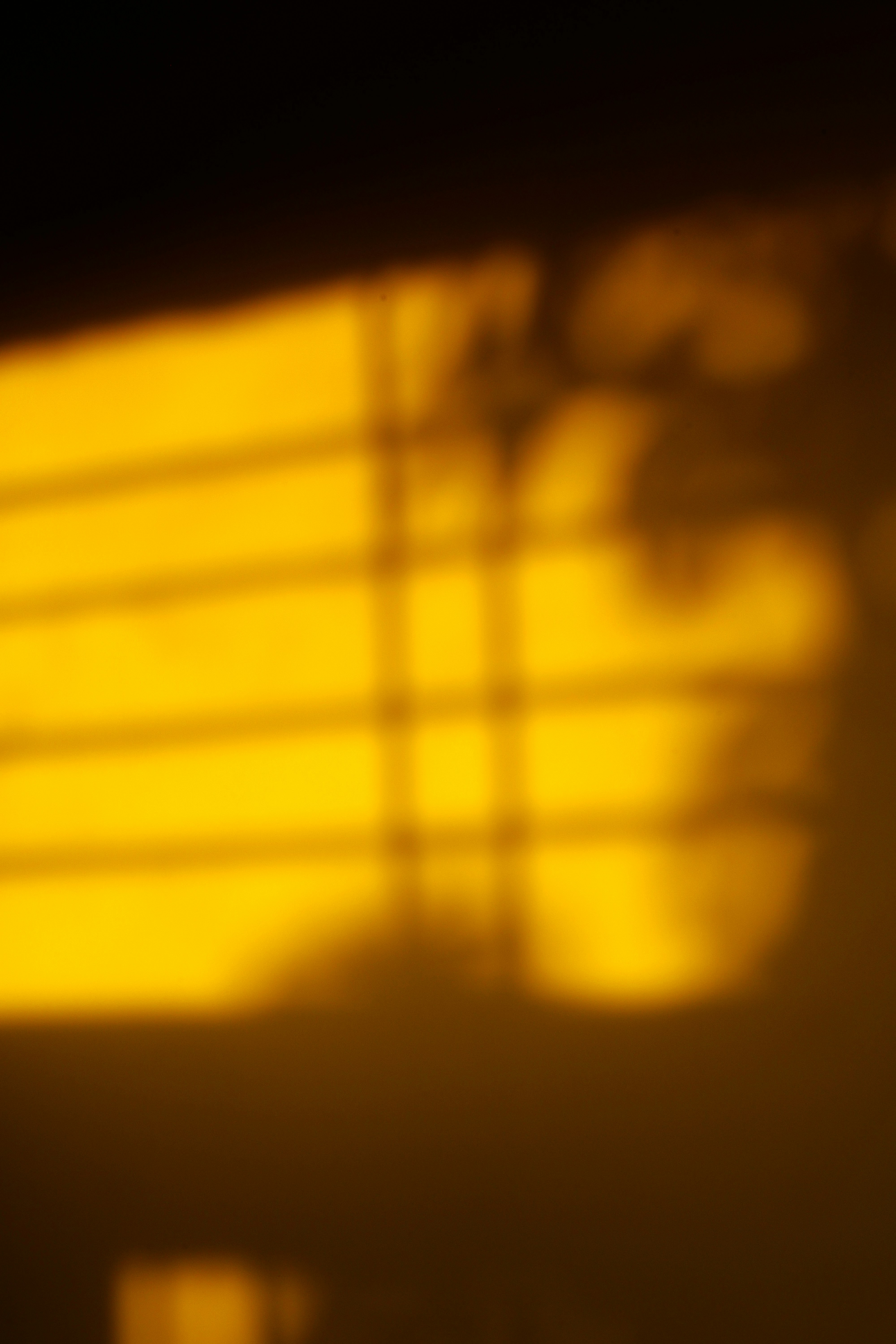 Shadowed City Lines: A Golden Window Through Blurred Echoes