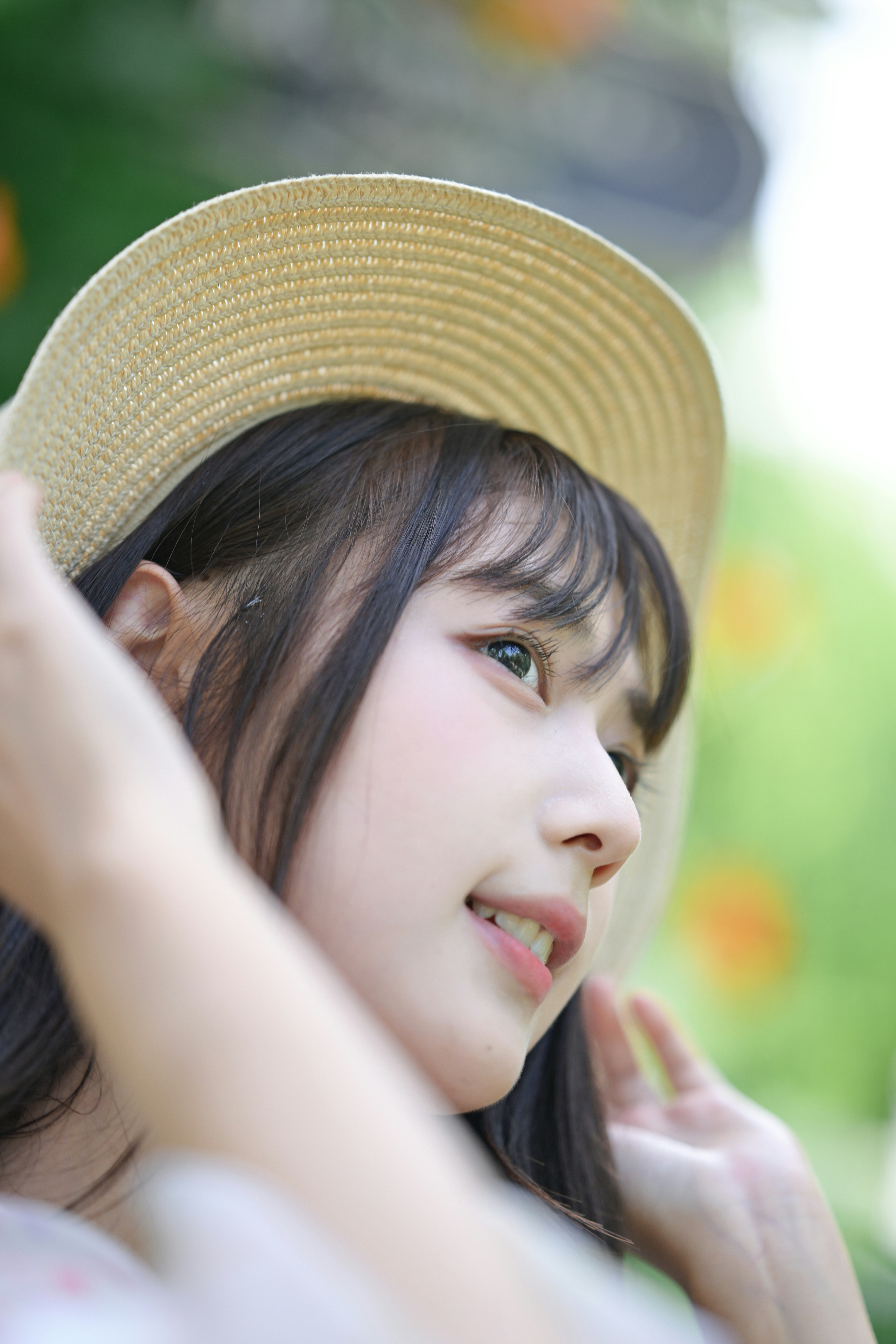 Sunlit Smile: A Closer Look at a Straw-Hatted Moment