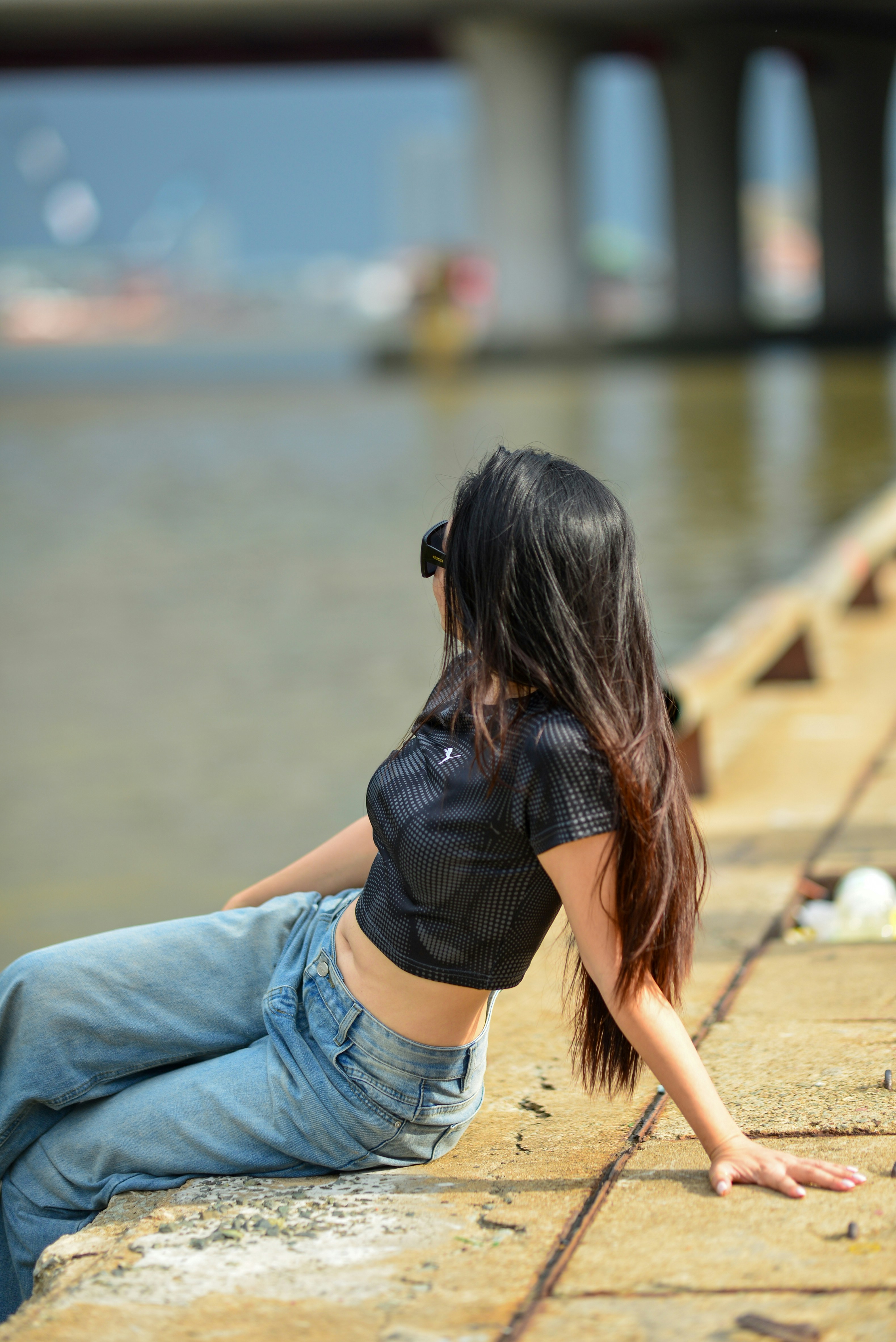 Portrait by the Pier: Relaxed Style on the Riverside Concrete