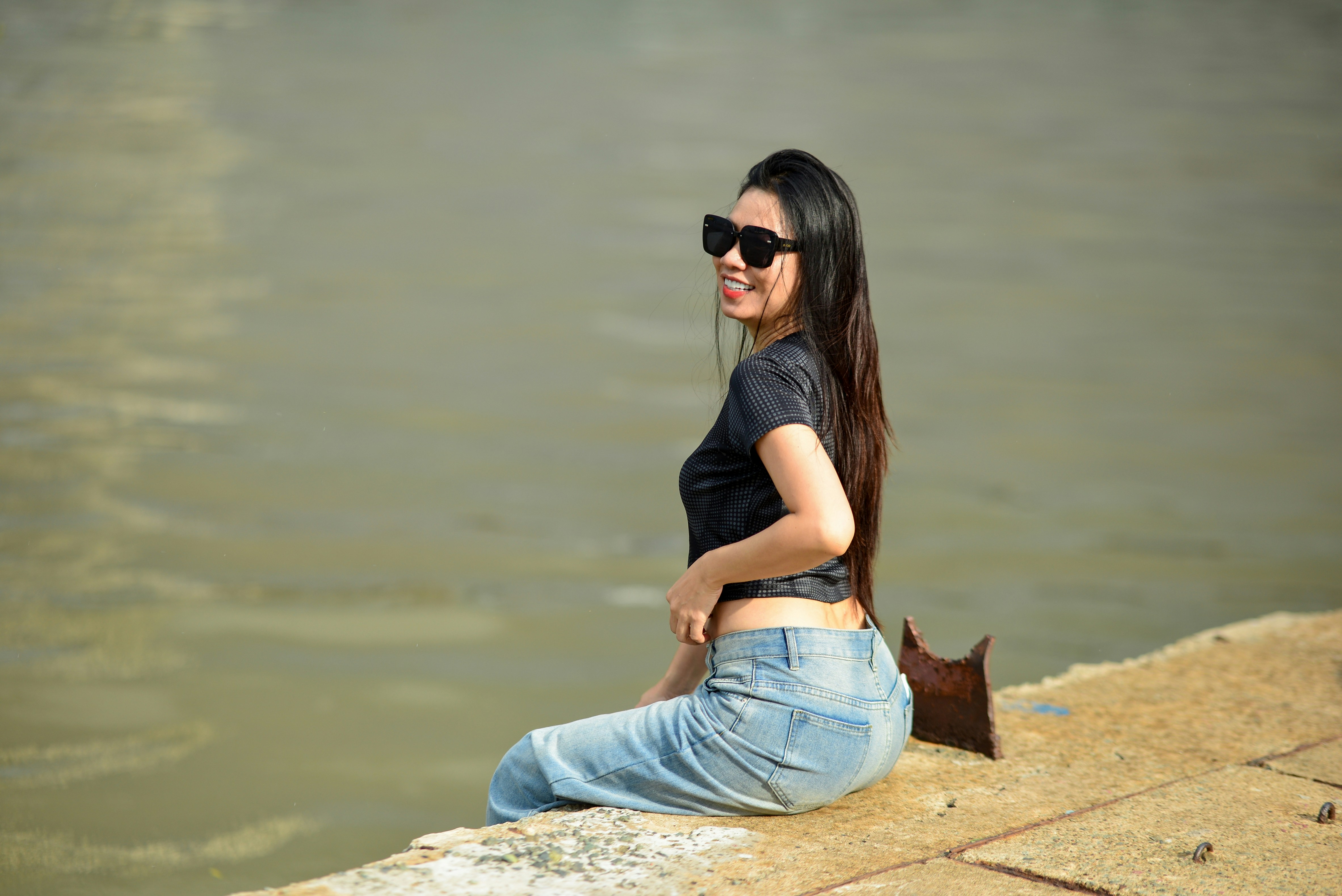 Against the Riverside Edge: A Laughing Moment in Denim