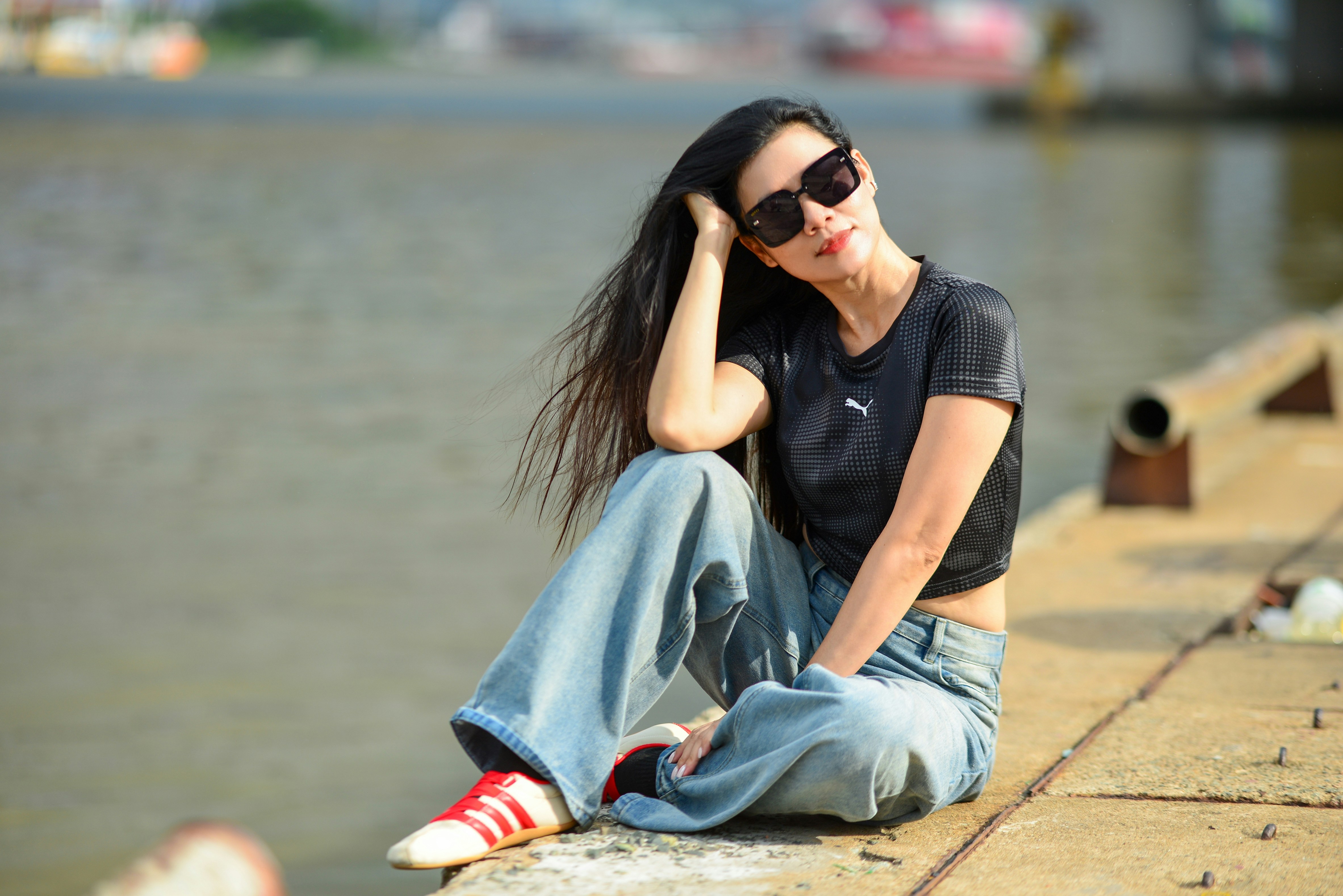 Relaxed by the River: A Quiet Portrait in Denim and Sunglasses