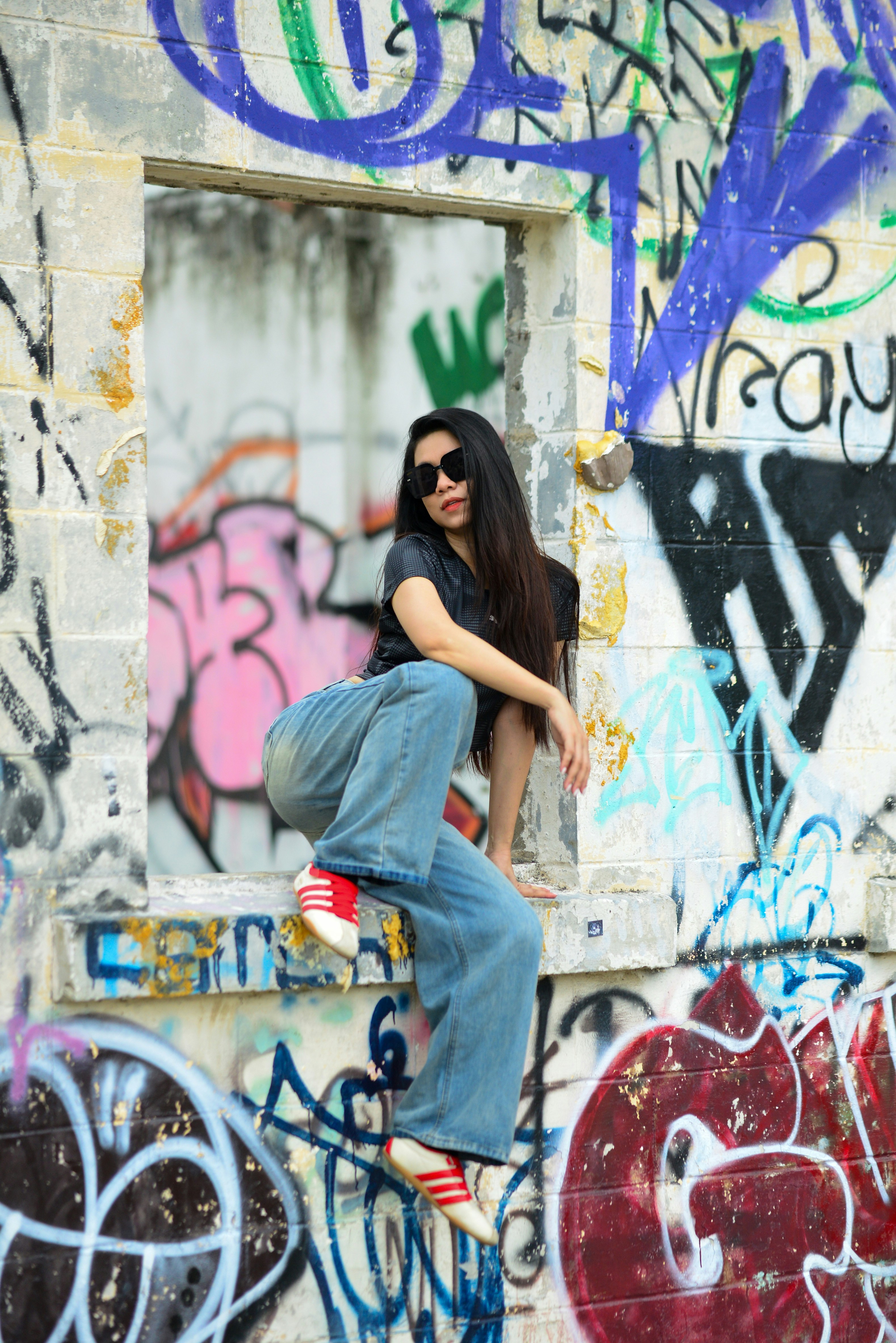 Graffiti Veil: A Neon-Clad Pose Across the Crumbling Wall