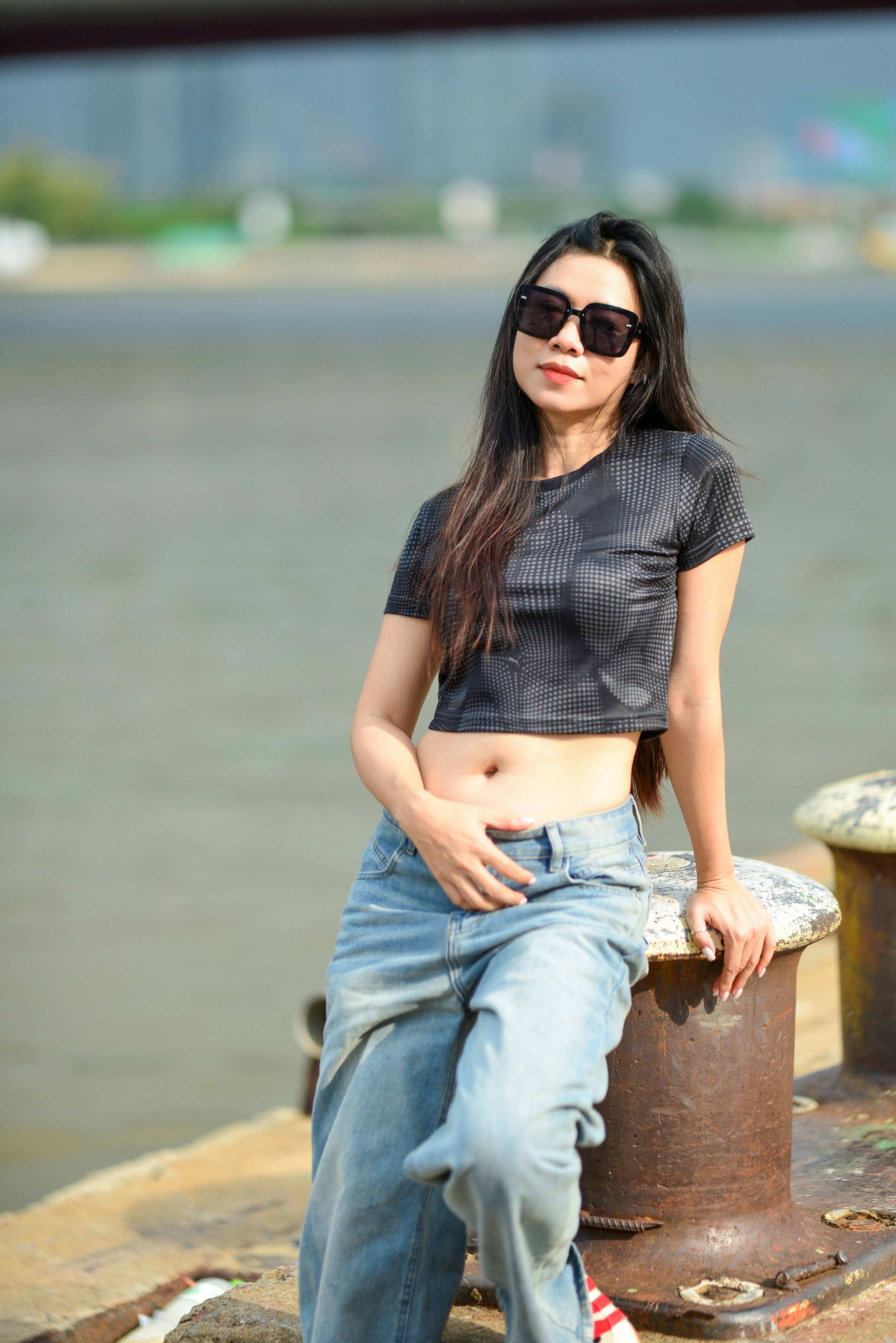 Effortless poise by the water: cropped calm amid urban haze