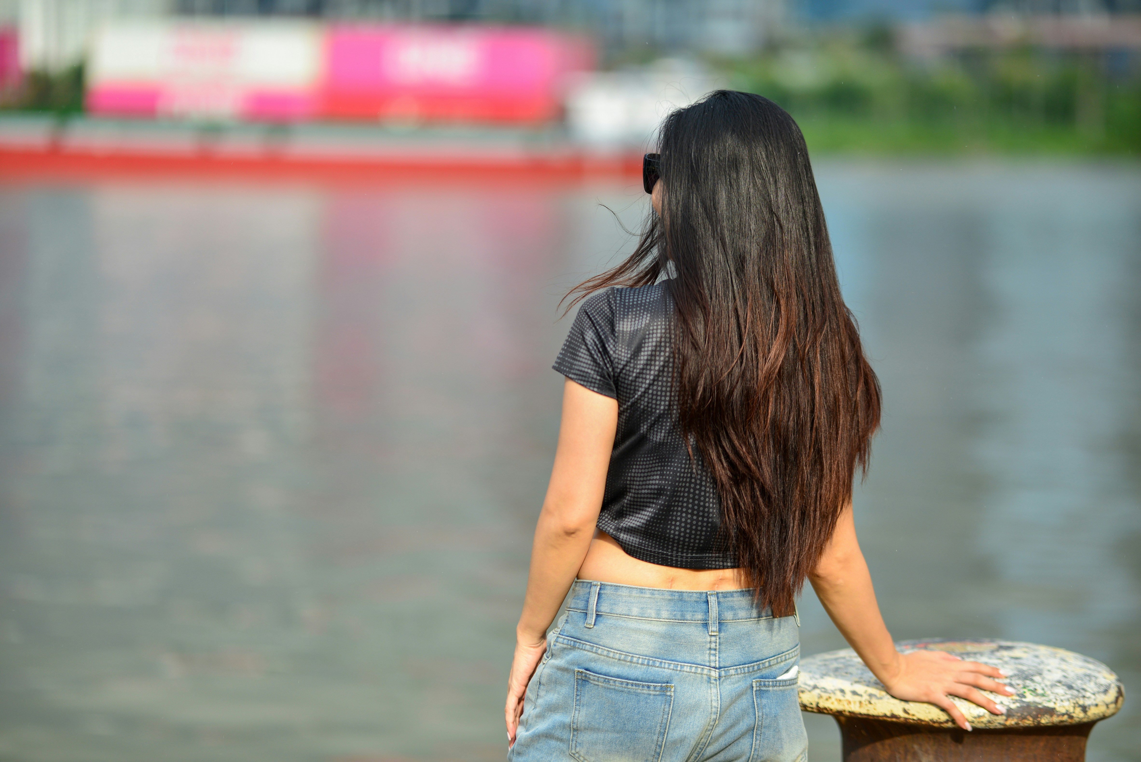 Backlit by the water: a viewer’s eye settles on the curve of hair and denim