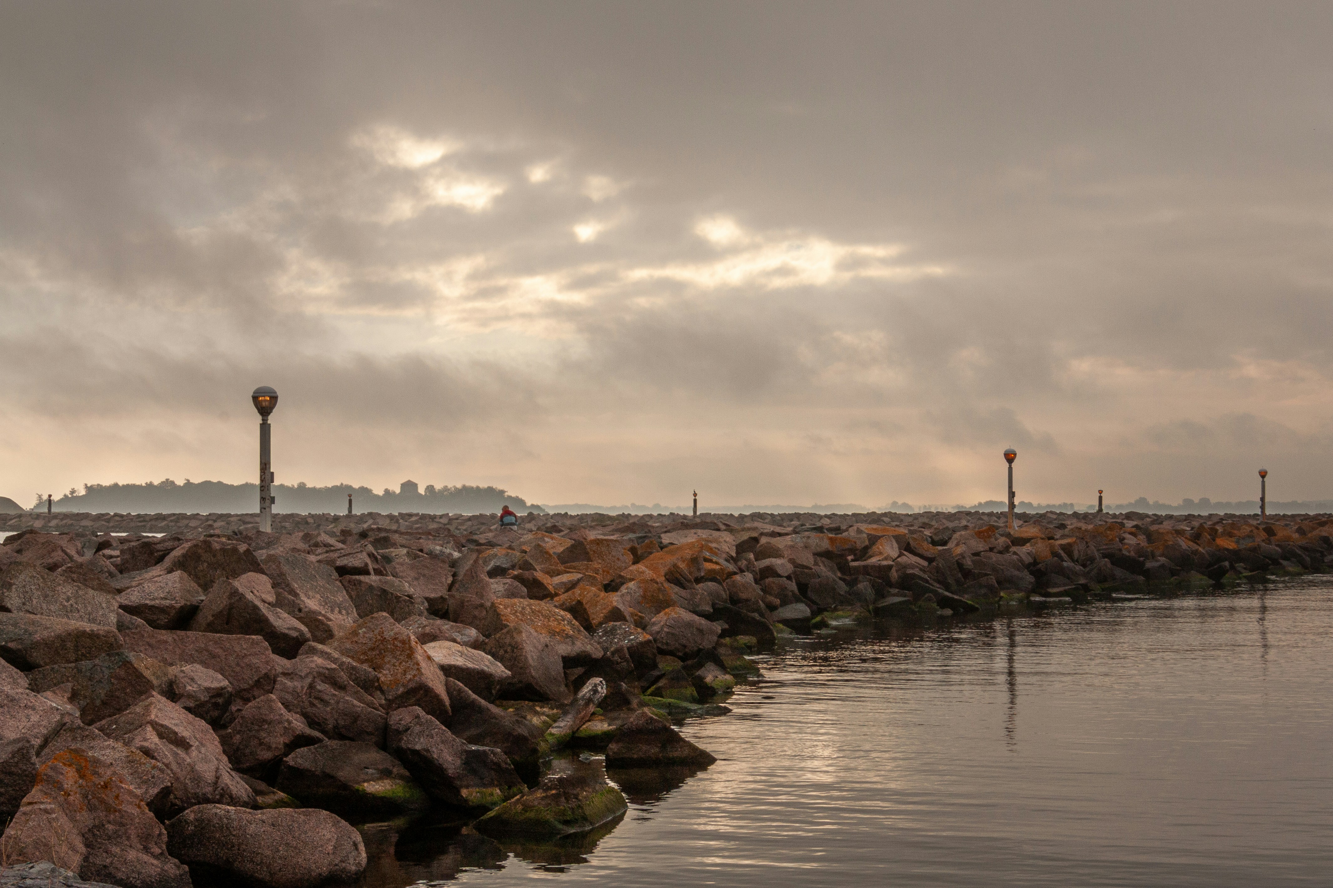 Misty Breakwater: Rocky Seawall Reaching Toward a Quiet Horizon