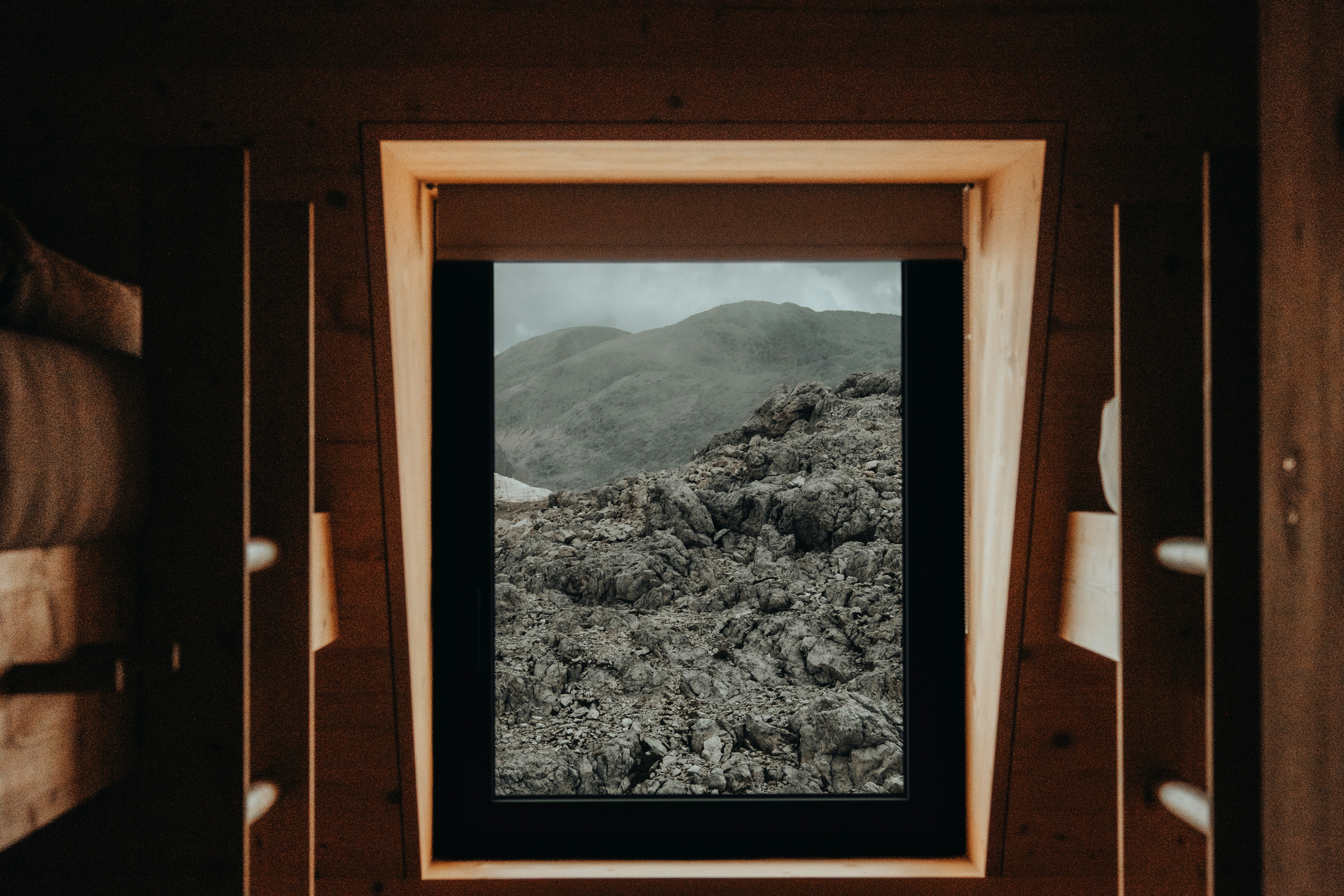 Window to the Dust: A Mountain Vista Framed by Timber and Shadow
