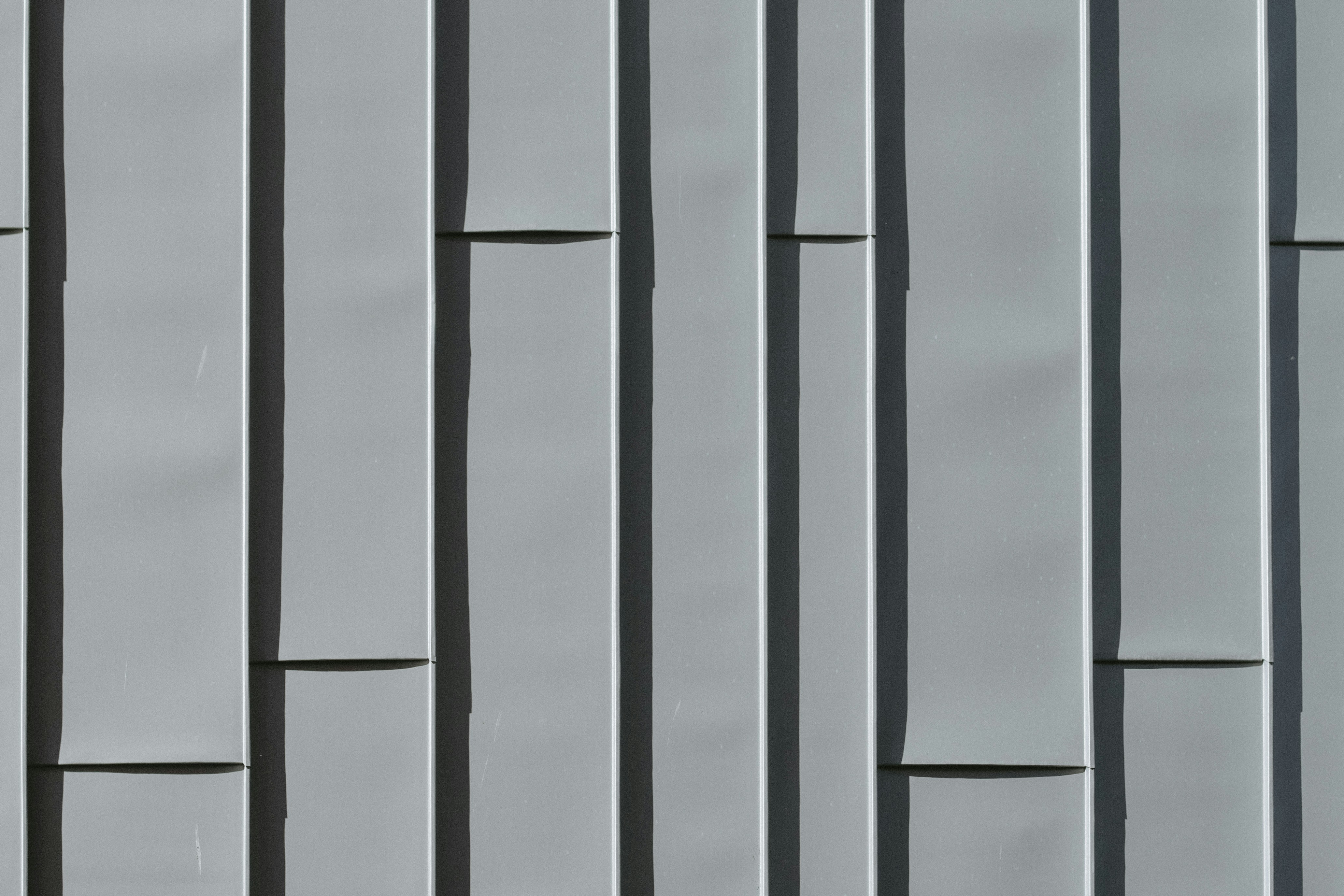 Vertical Slats in Grey Facade: A Study in Repetition and Light