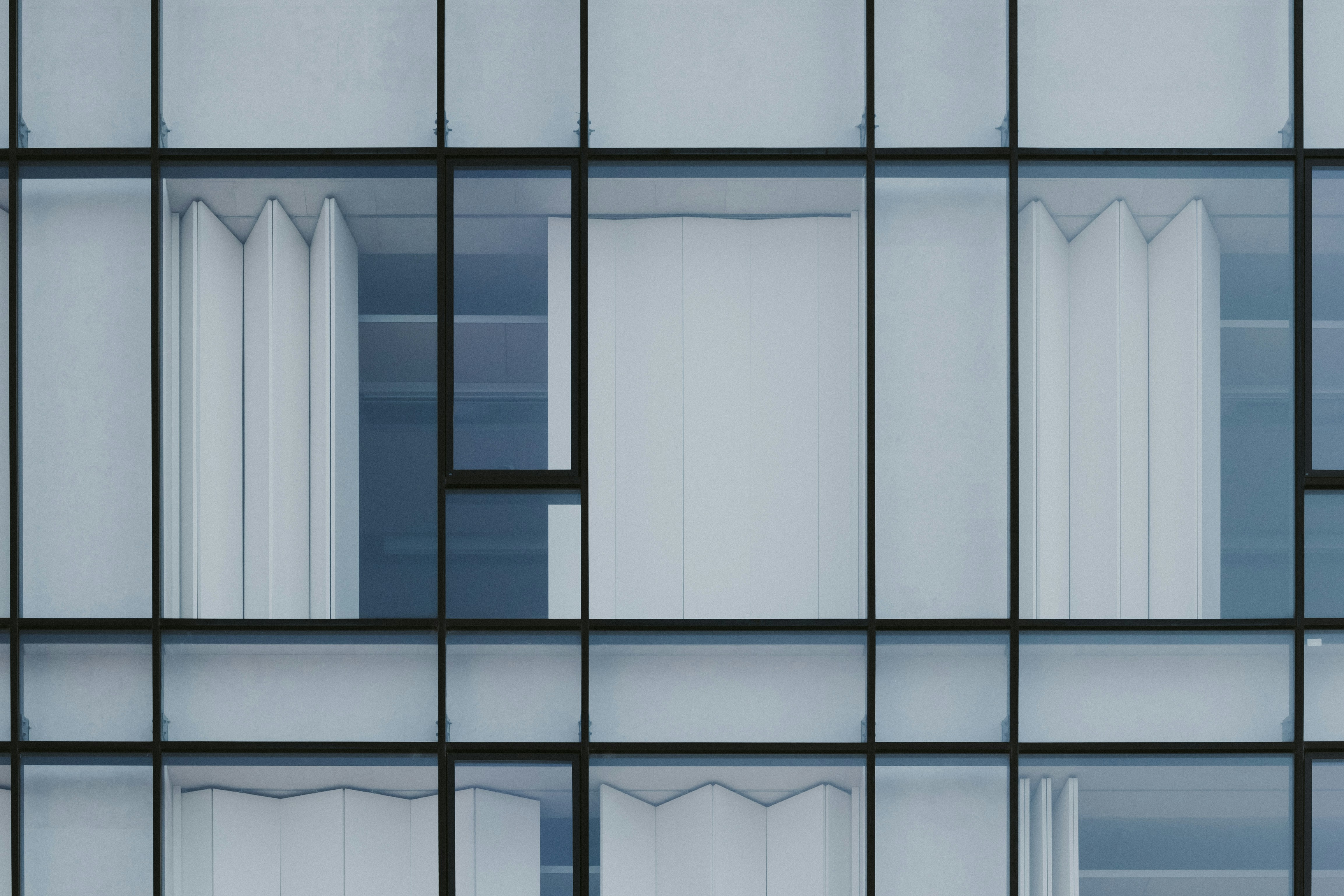 Grid of Glass: Repetition and Quiet Shadows in Modern Facade
