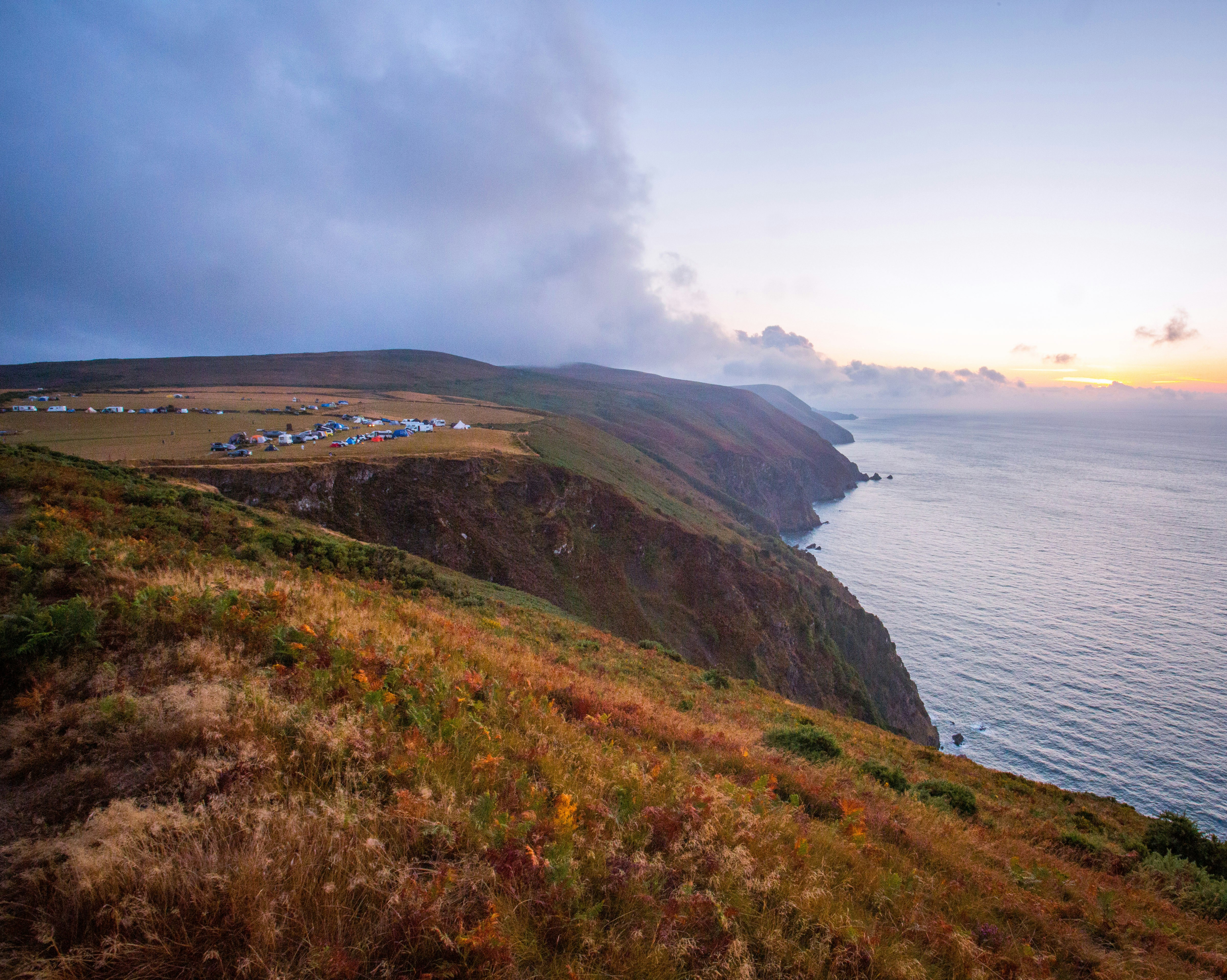 Clifftop Village at Dusk: Coastal Meadow Meeting the Atlantic