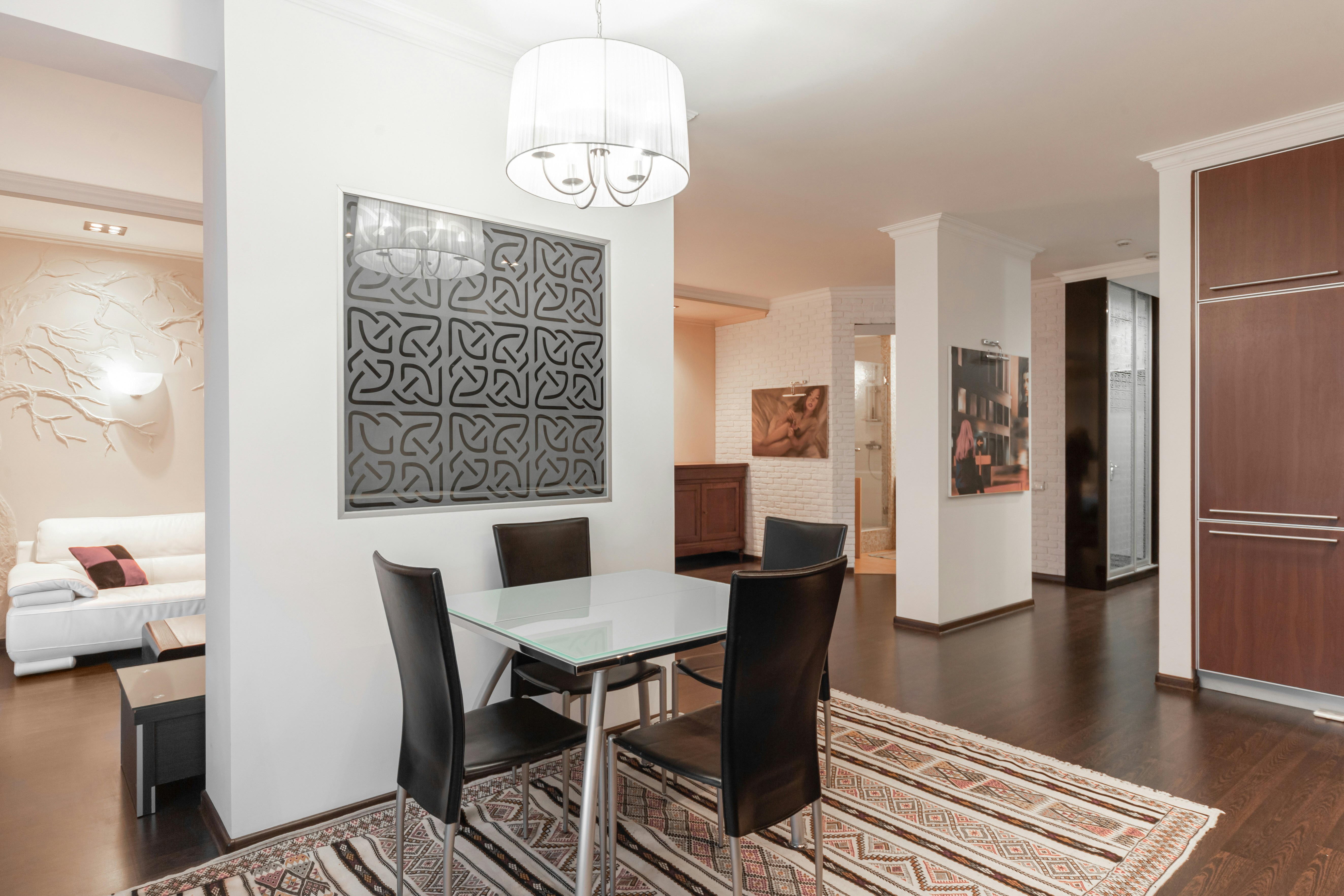 Open-Plan Living Room with Glass Dining Table under Pendant Light